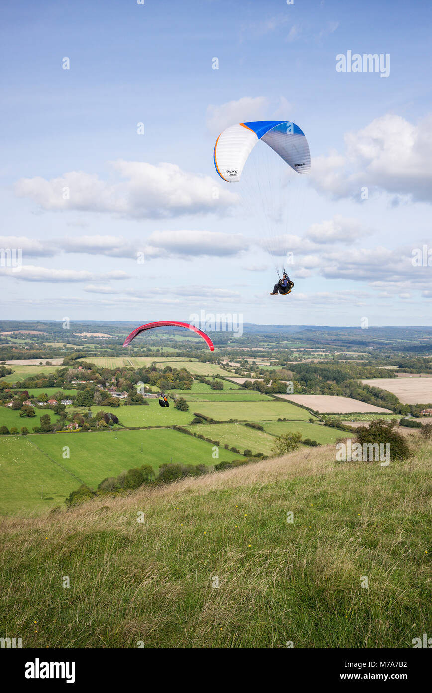 Paraglider flying above the north facing escarpment slope on Harting ...