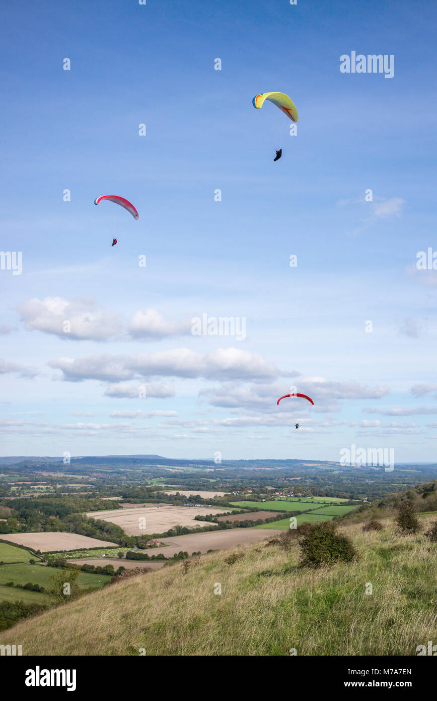 Paragliders flying above the north facing escarpment slope on Harting ...