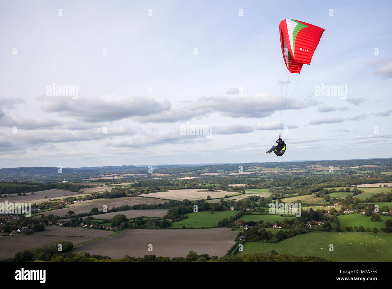 Paraglider flying above the north facing escarpment slope on Harting ...