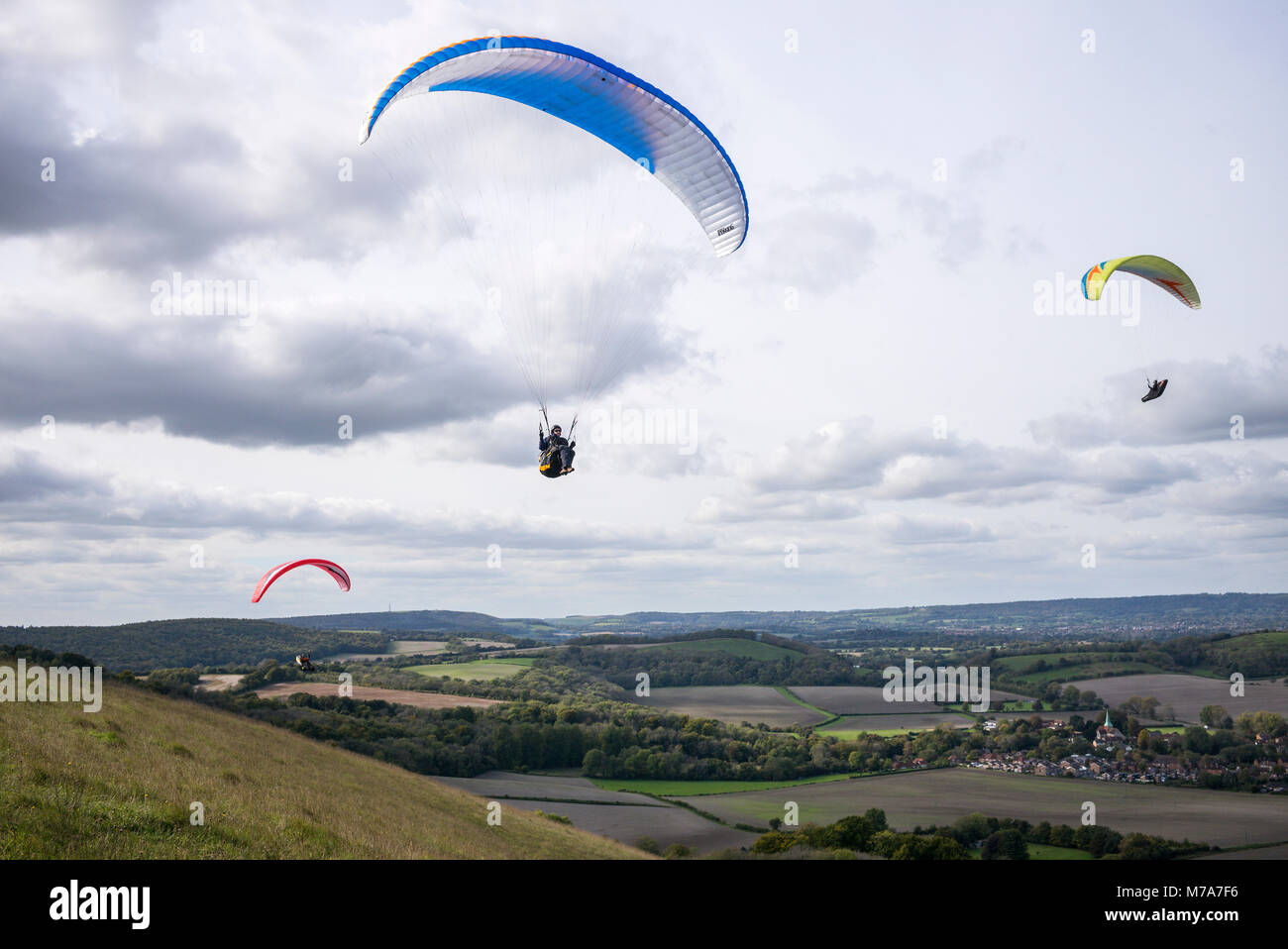 Paragliders flying above the north facing escarpment slope on Harting ...