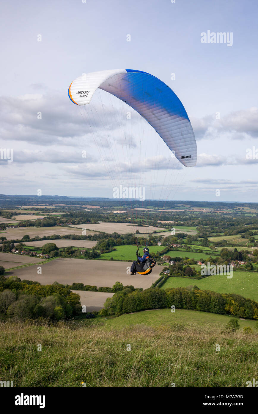 Paraglider flying above the north facing escarpment slope on Harting ...
