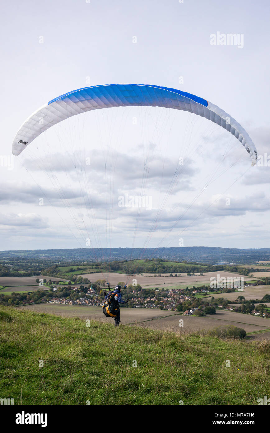 Paraglider pilot taking off into the wind from the north facing ...