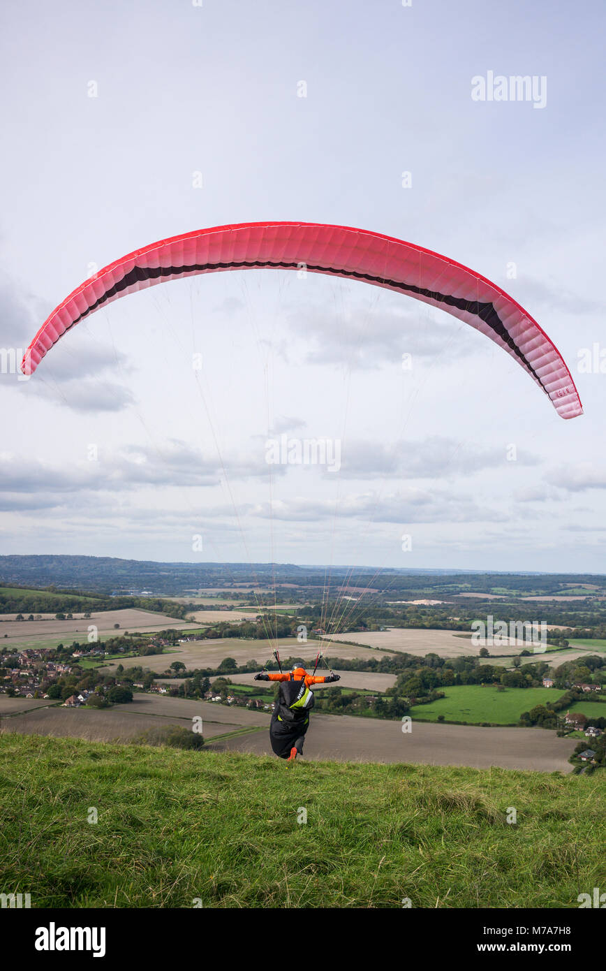 Paraglider pilot taking off into the wind from the north facing ...