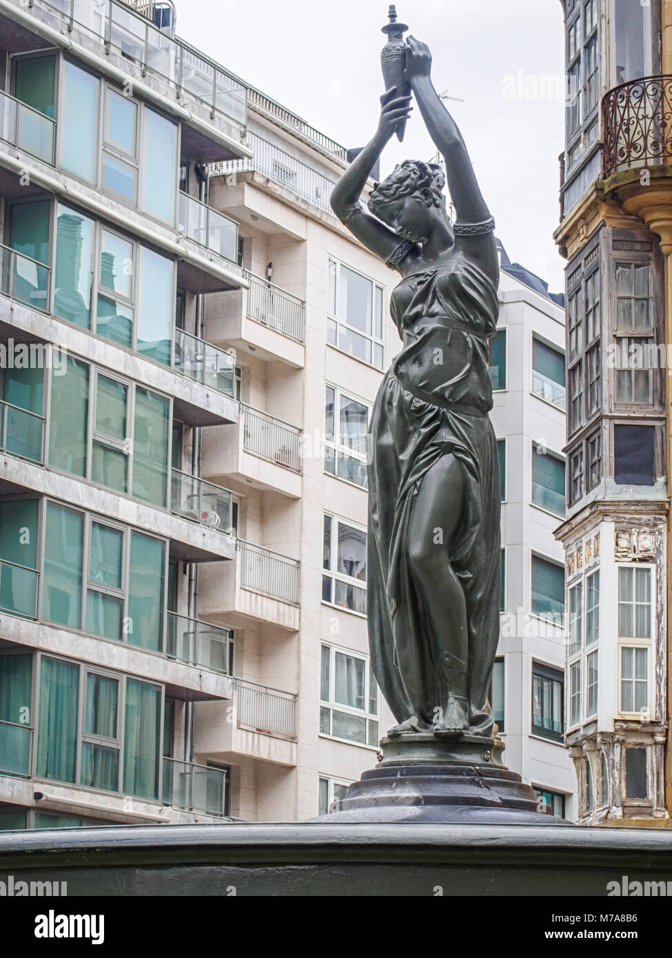 Girl with amphora statue of a fountain in San Sebastian, Basque Country ...