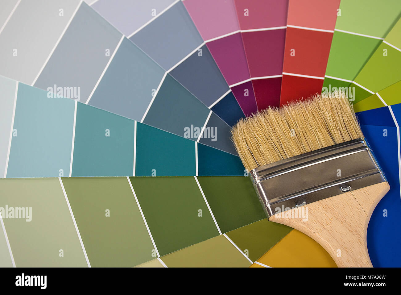 paint brush on color paint swatches Stock Photo - Alamy