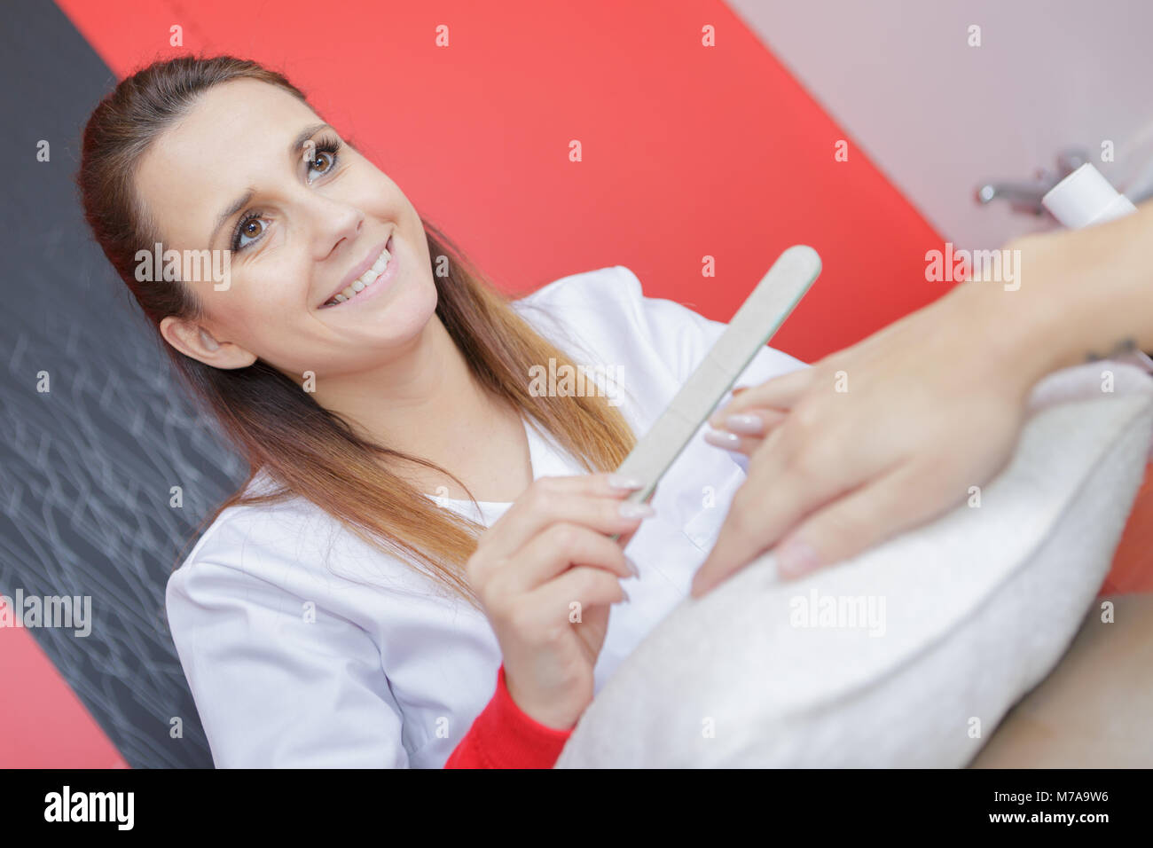 portrait of an attractive nail salon worker giving a manicure Stock ...