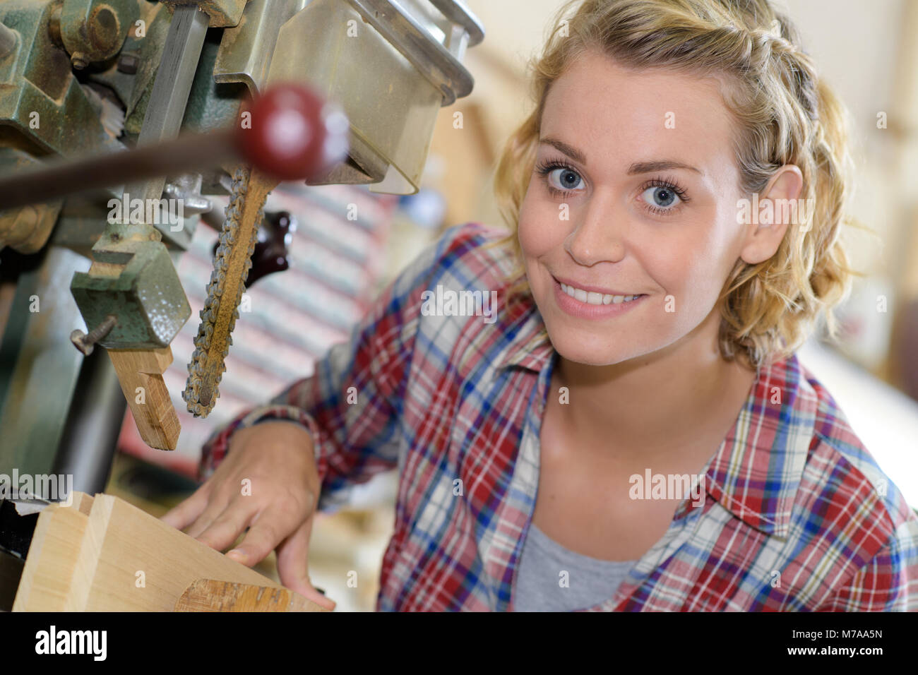 beautiful female carpenter at work using vertical drilling machine Stock Photo - Alamy