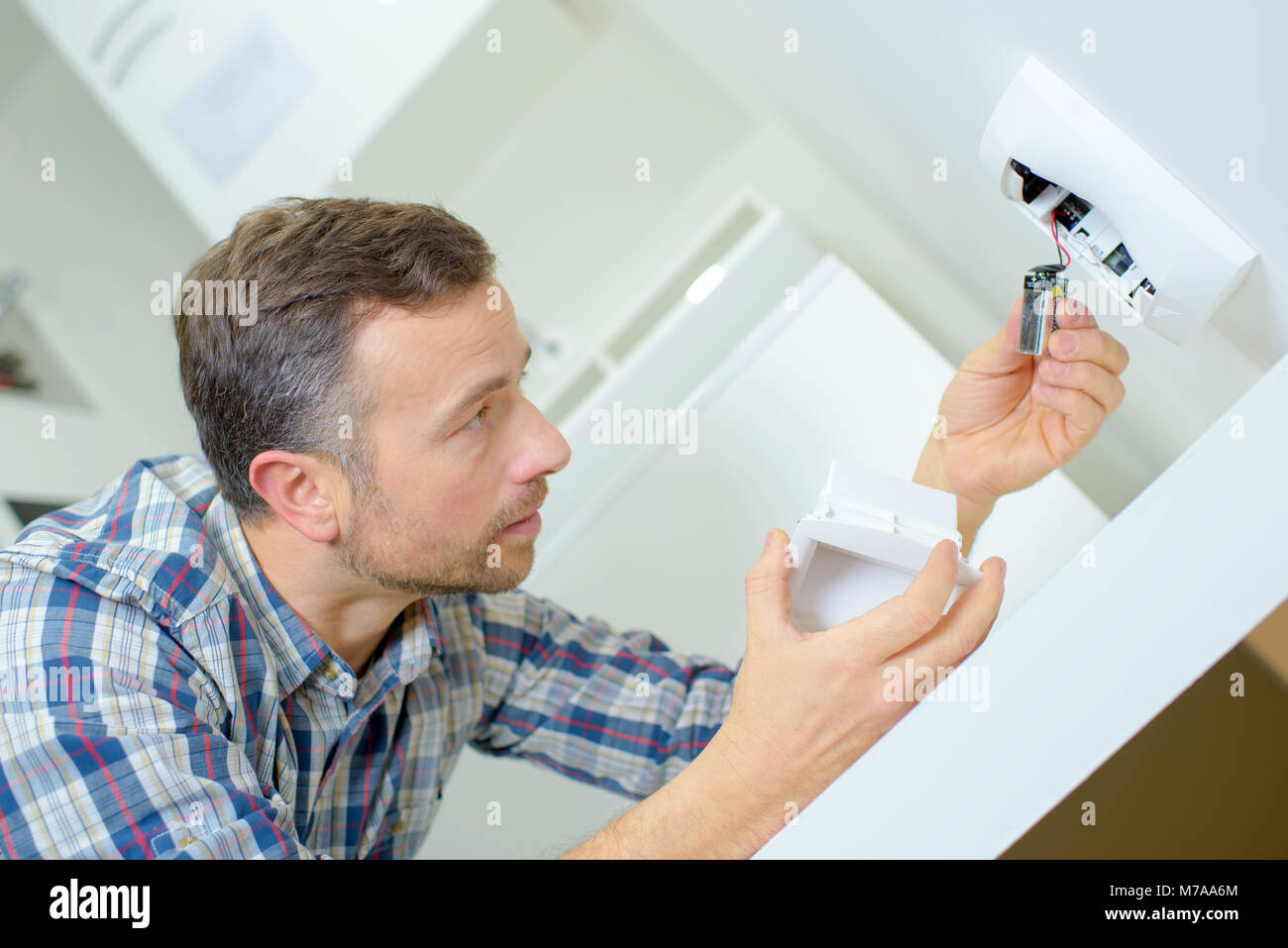 Man fitting an air vent Stock Photo - Alamy