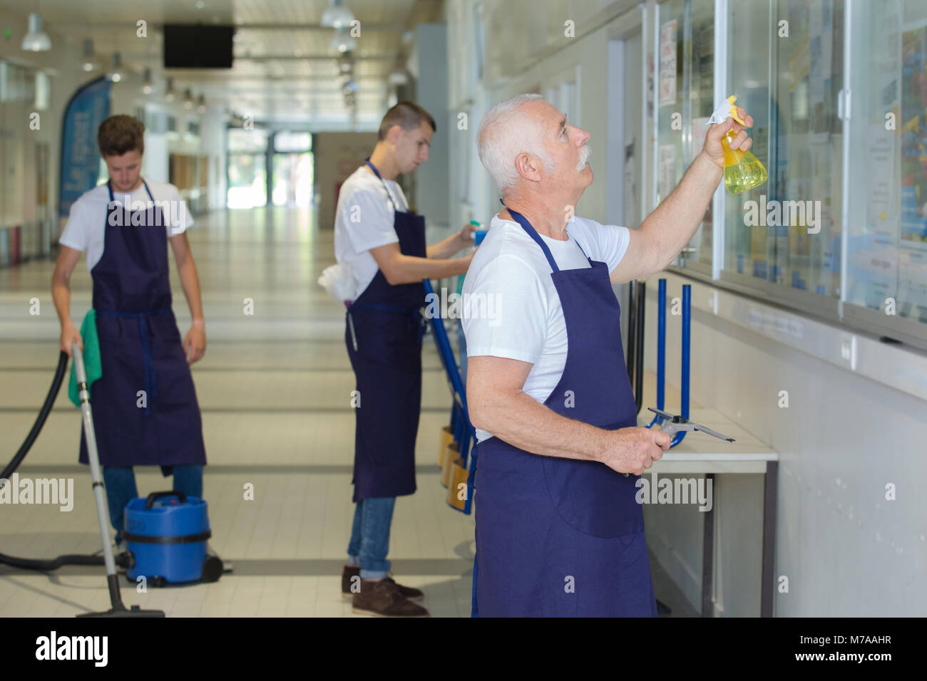 team of men cleaning the office as a job Stock Photo - Alamy