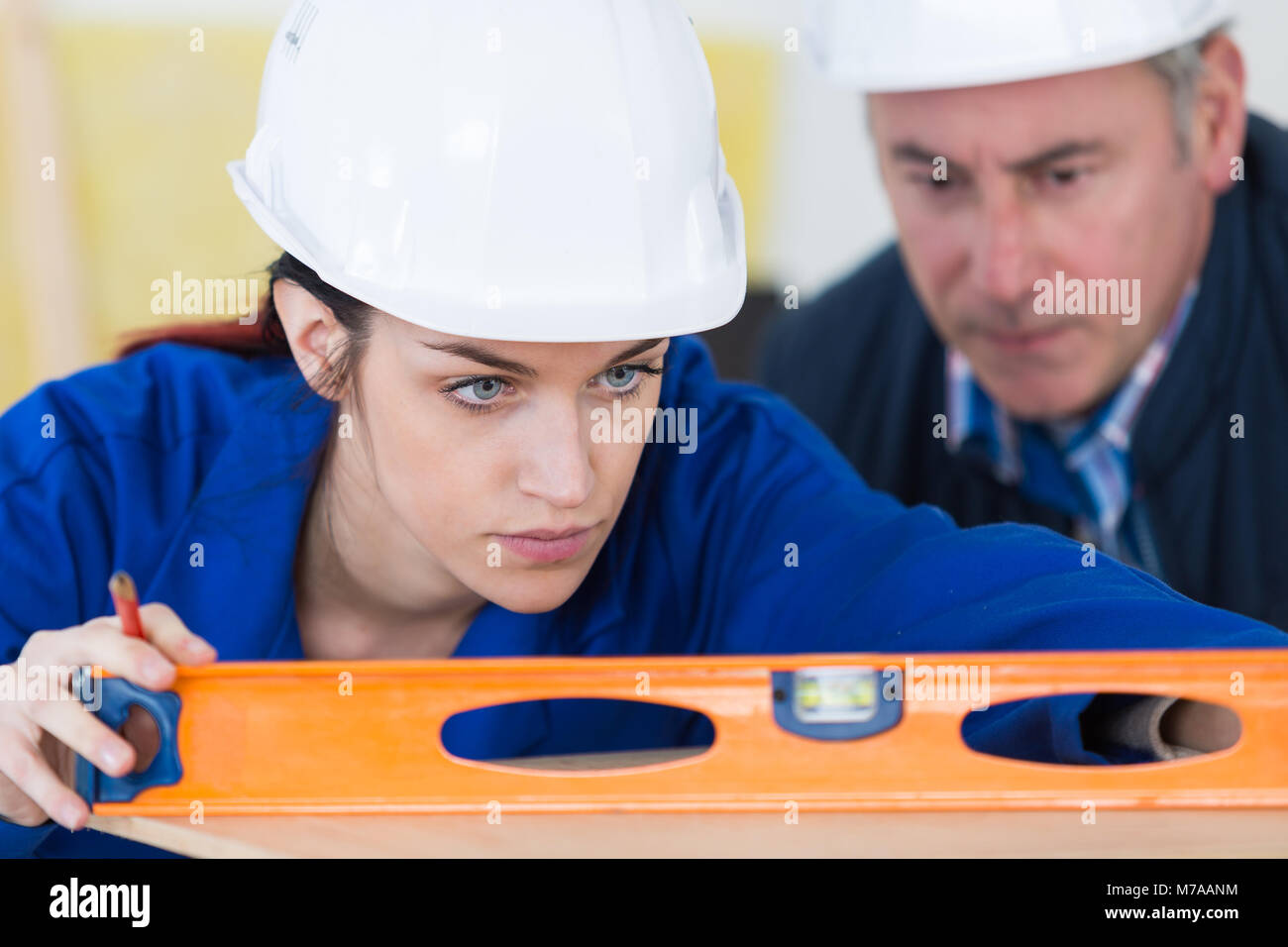 pretty carpenter with spirit level Stock Photo - Alamy