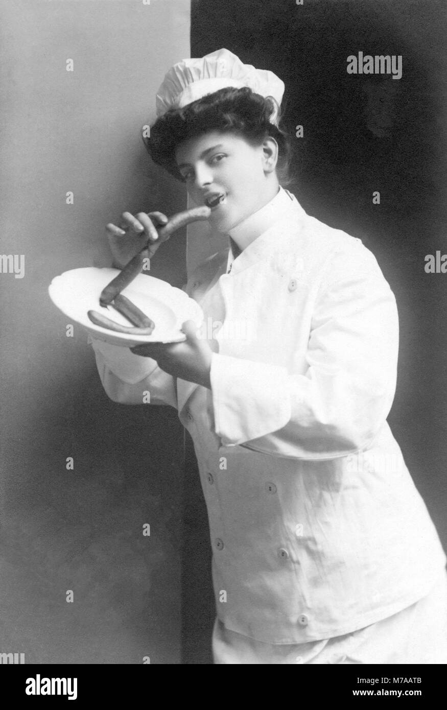 Female cook eats a sausage, 1910s, Germany Stock Photo - Alamy