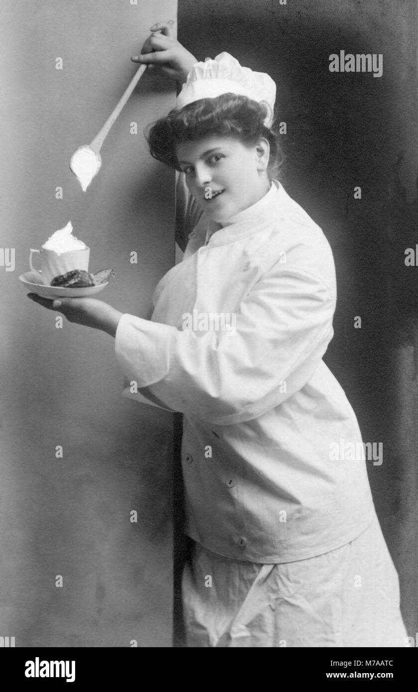 Female cook puts icing on the coffee, 1910s, Germany Stock Photo - Alamy