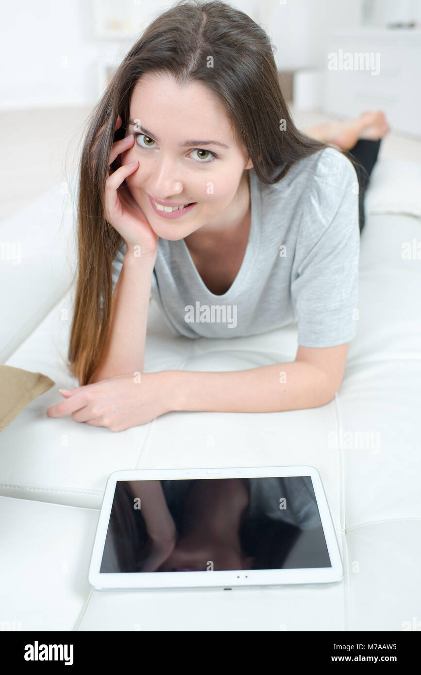 girl posing next to a tablet Stock Photo - Alamy