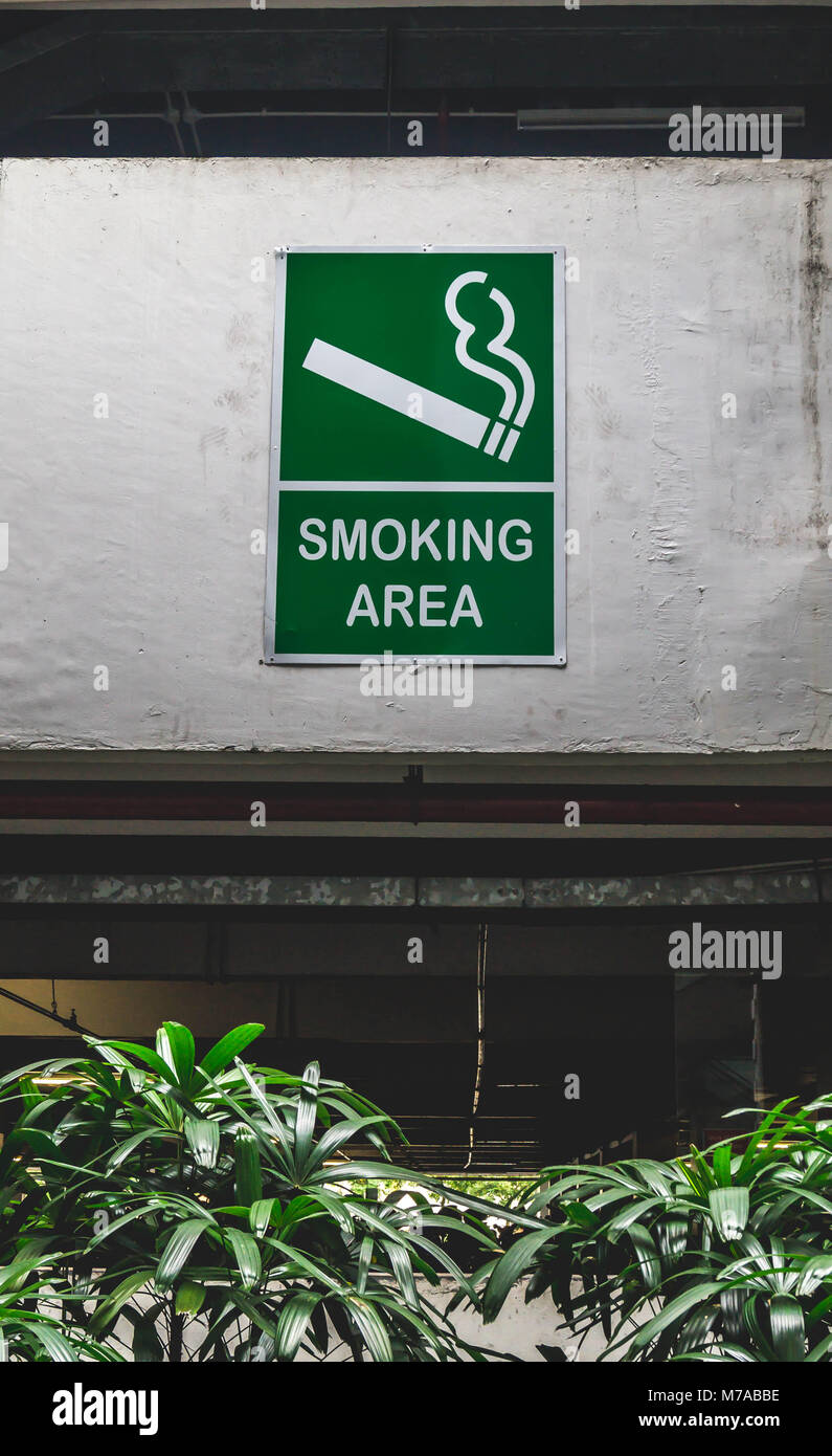 smoking designated area sign mounted in the wall in open space Stock ...