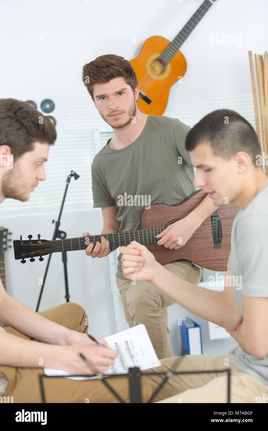 Group three friends play guitar hi-res stock photography and images - Alamy