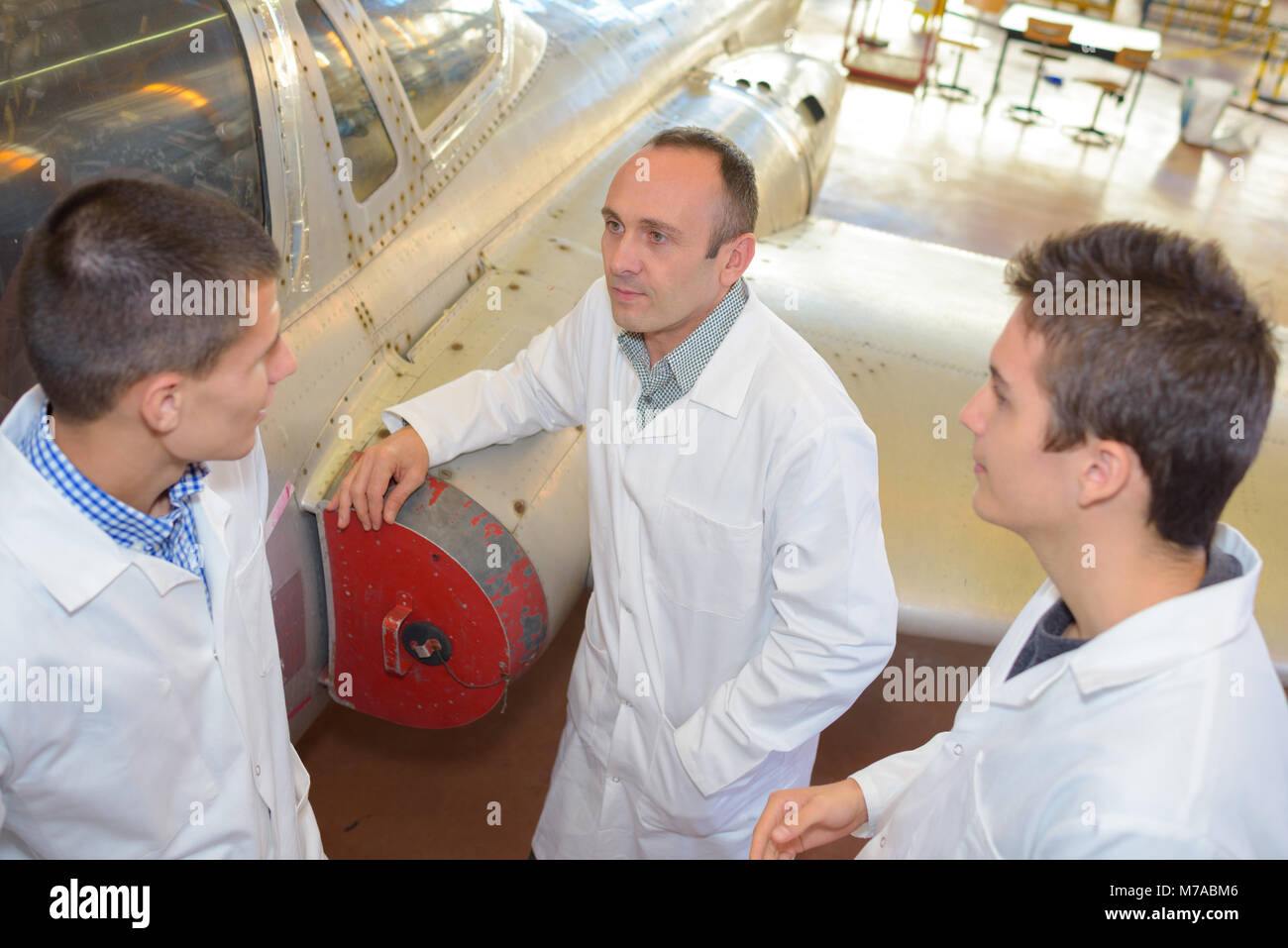 Students in aviation hangar Stock Photo - Alamy
