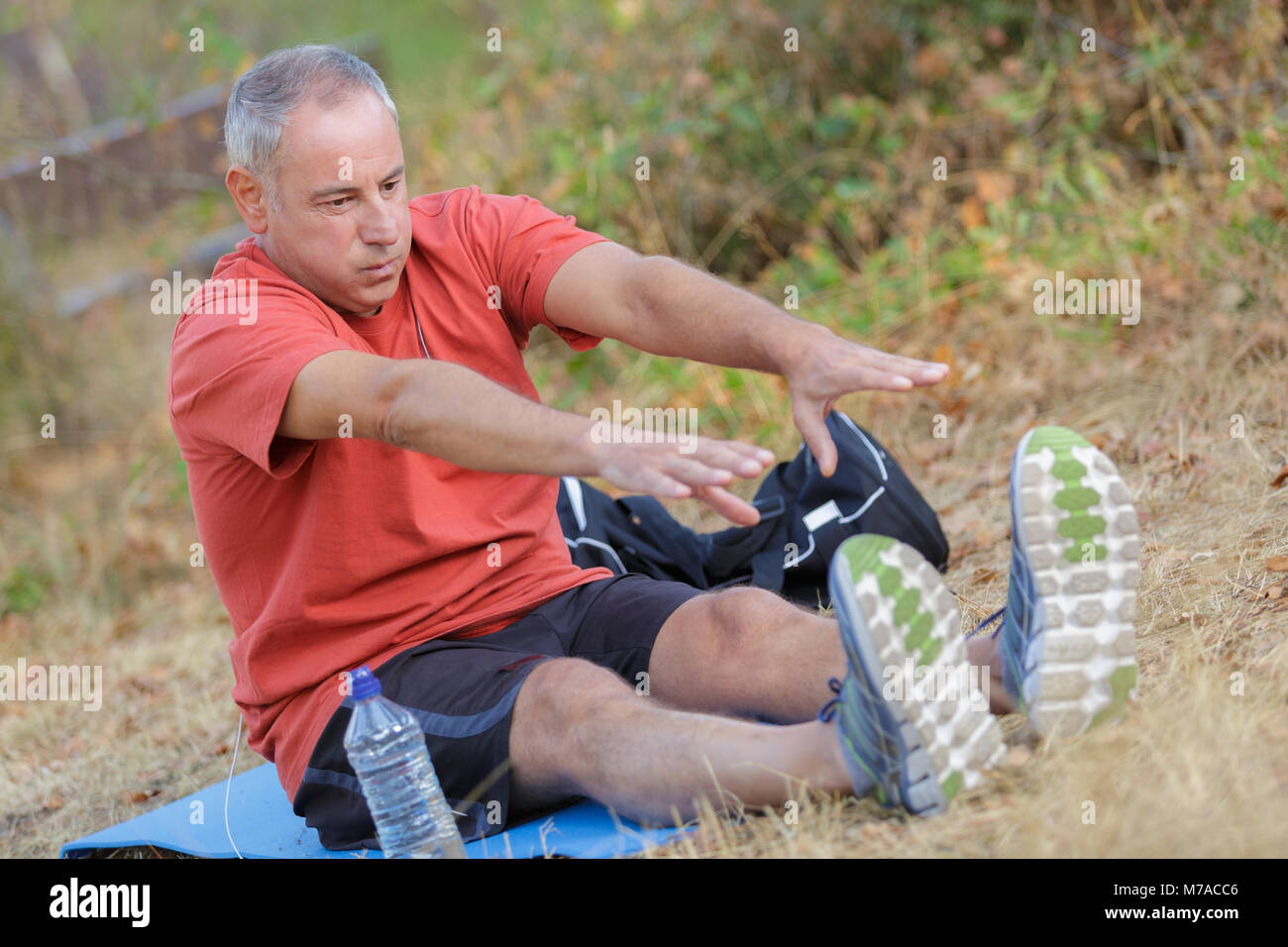 man trying to reach his feet Stock Photo - Alamy