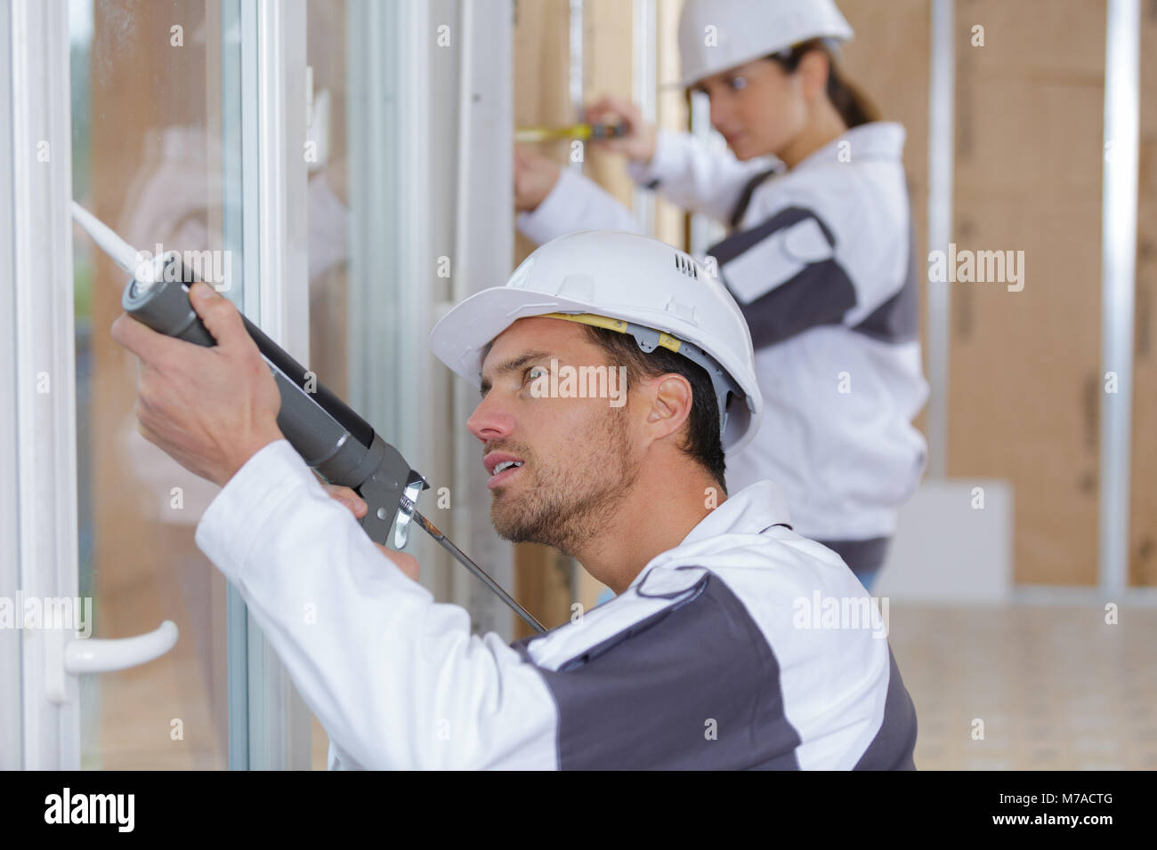 construction worker installing window in house Stock Photo - Alamy
