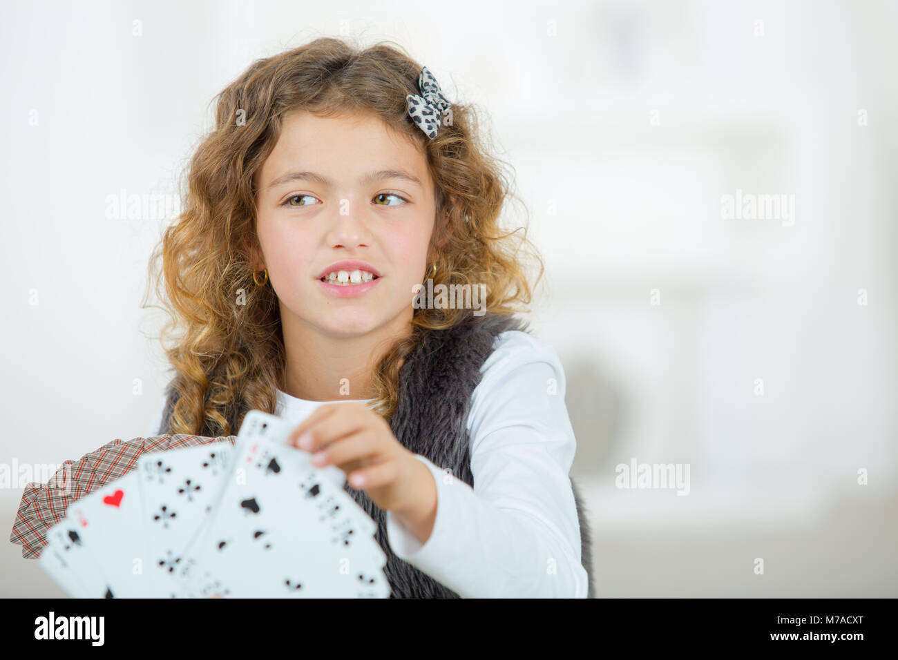Girl playing cards hi-res stock photography and images - Alamy