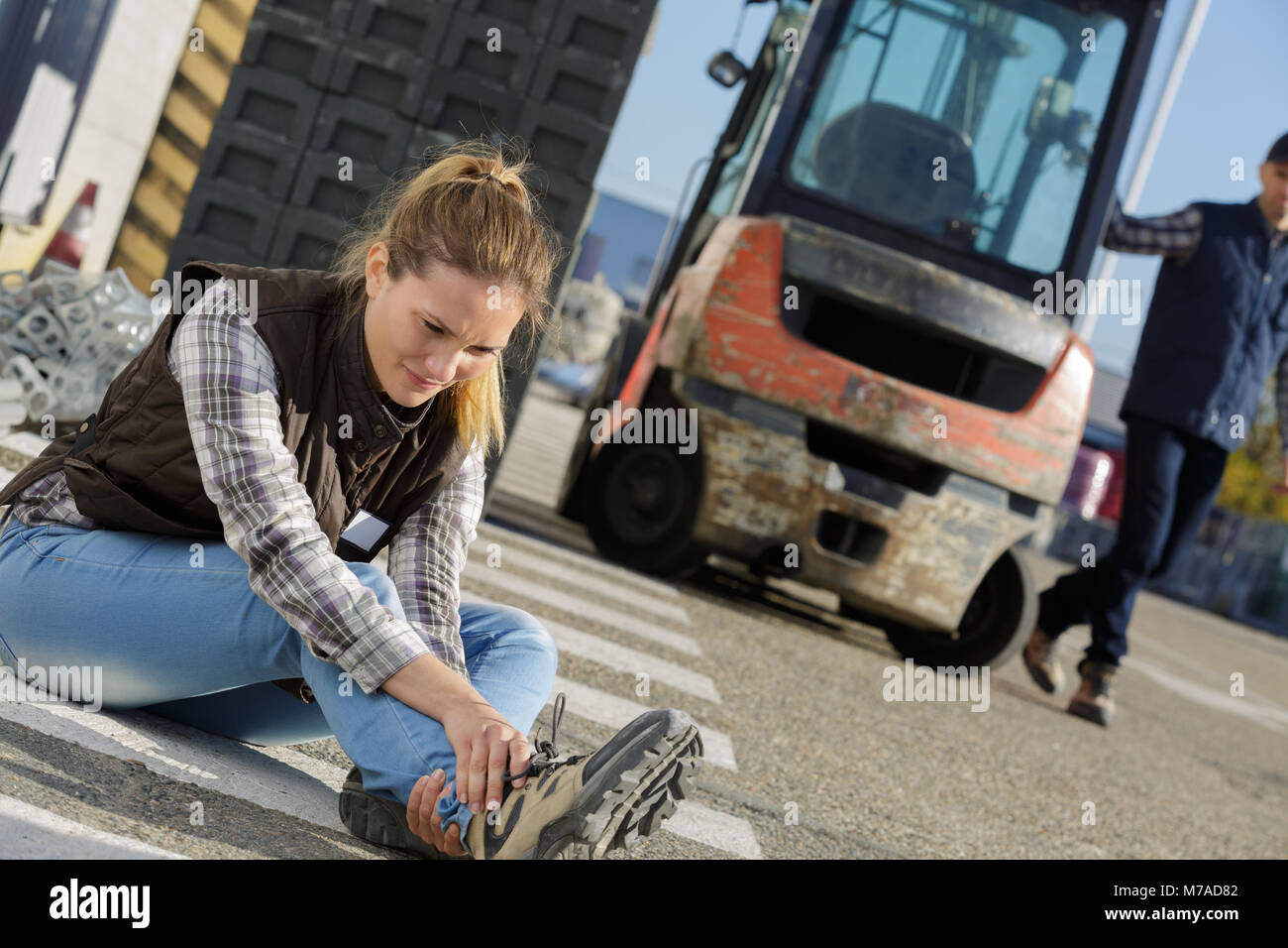 female colleague lying on the floor in a warehouse Stock Photo - Alamy