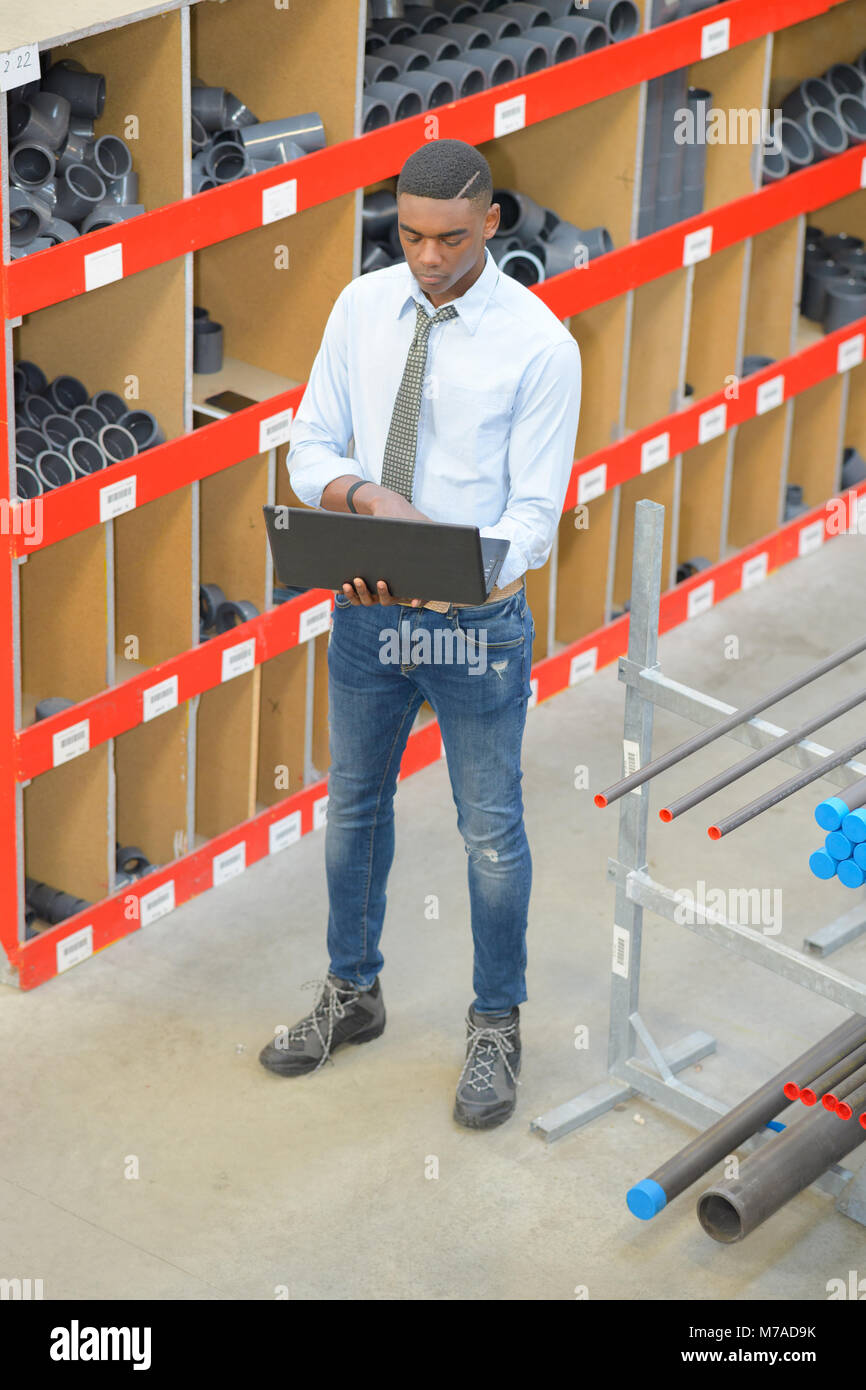 tube factory manager with laptop Stock Photo - Alamy