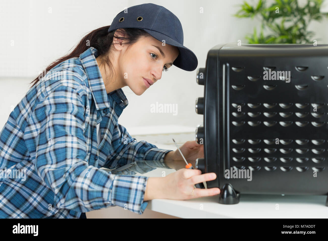 girl fixing appliance Stock Photo - Alamy