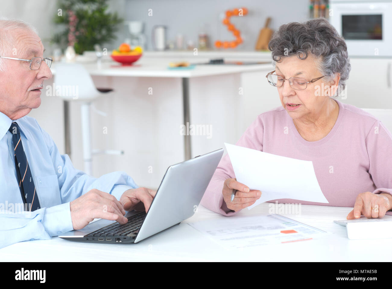 elderly lady dictating letter for husband to type on laptop Stock Photo ...