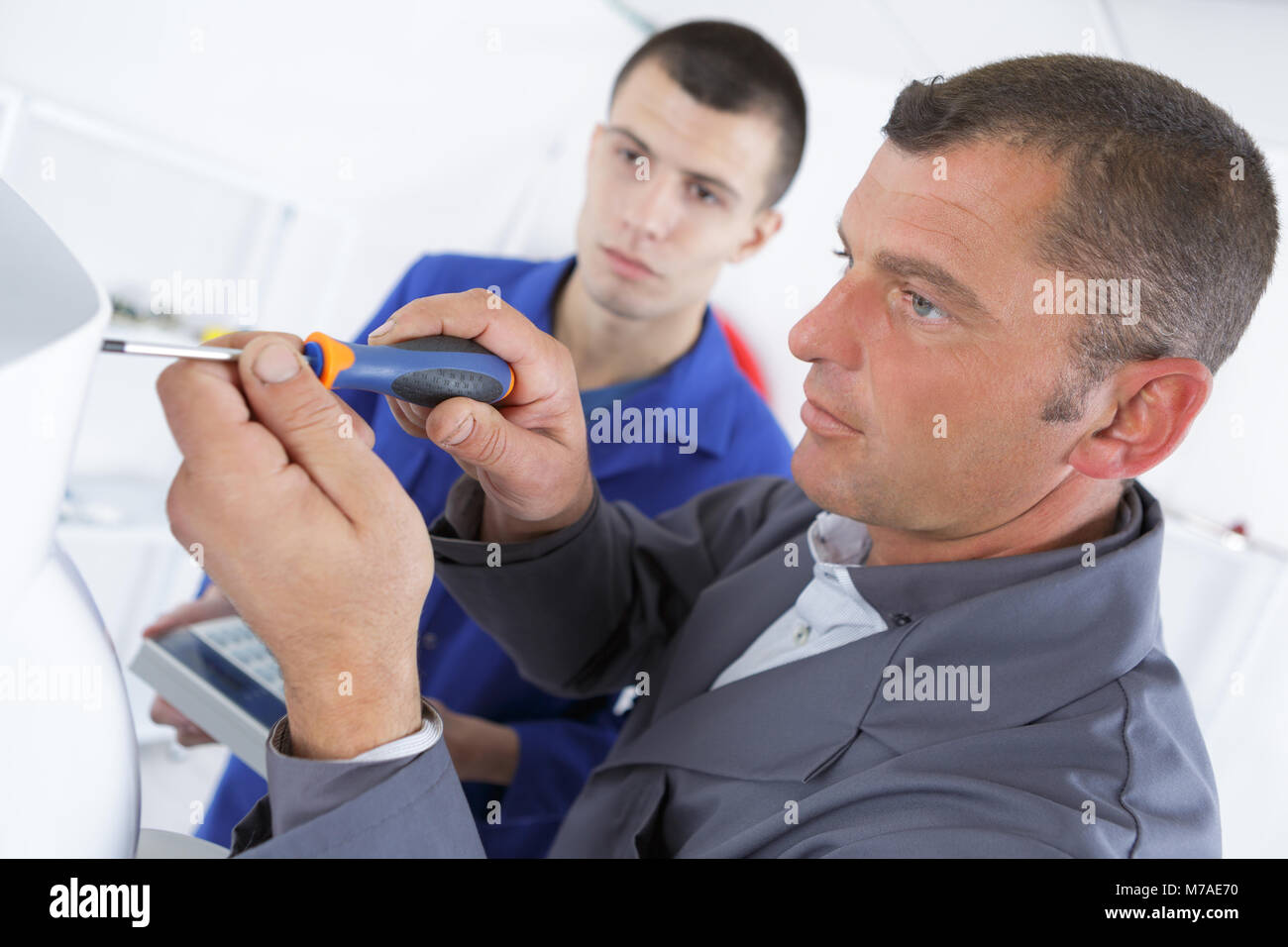 man fixing electronic circuits in service center Stock Photo - Alamy