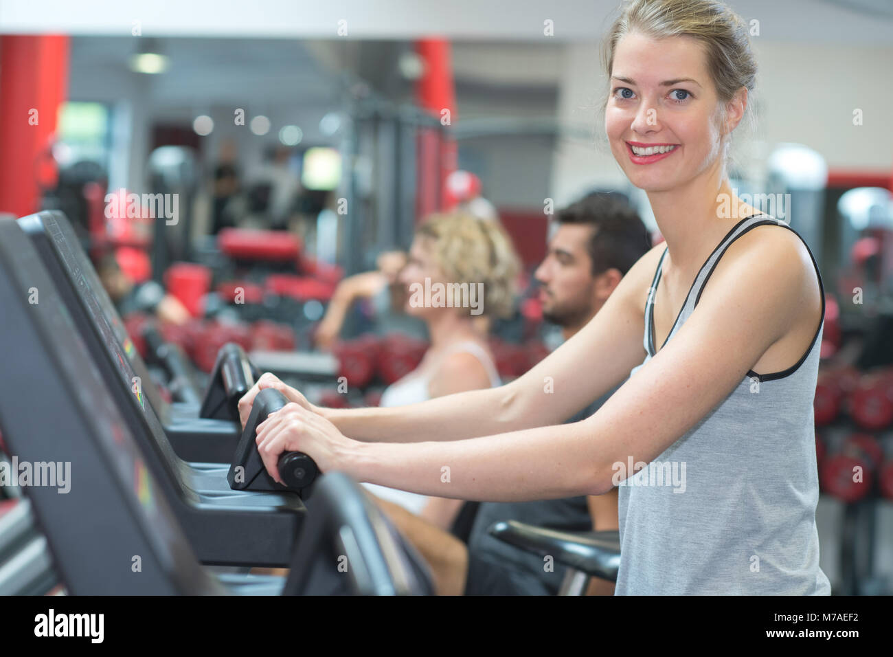 happy people doing indoor biking in a fitness club Stock Photo - Alamy