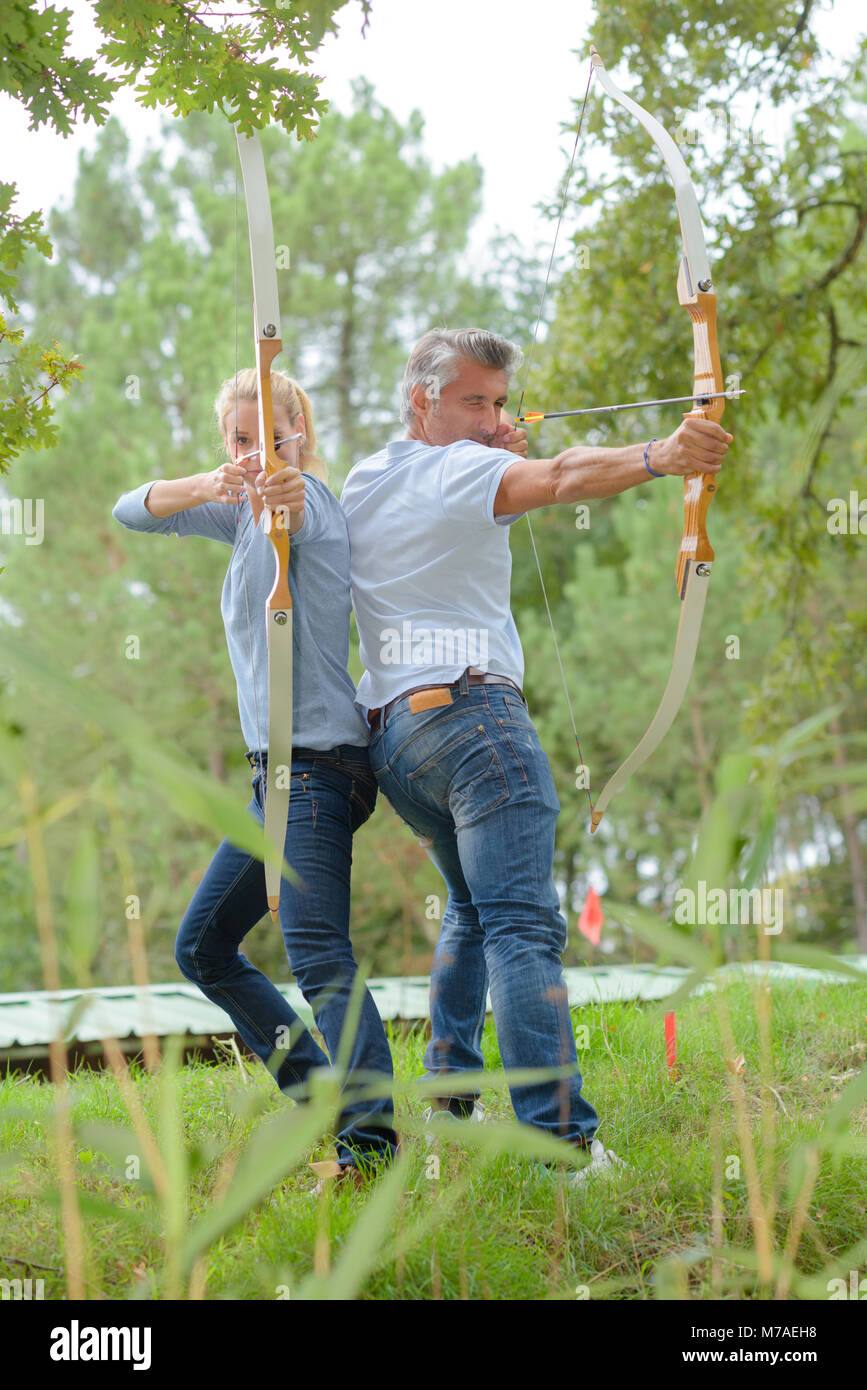 archer couple training with the bow Stock Photo - Alamy