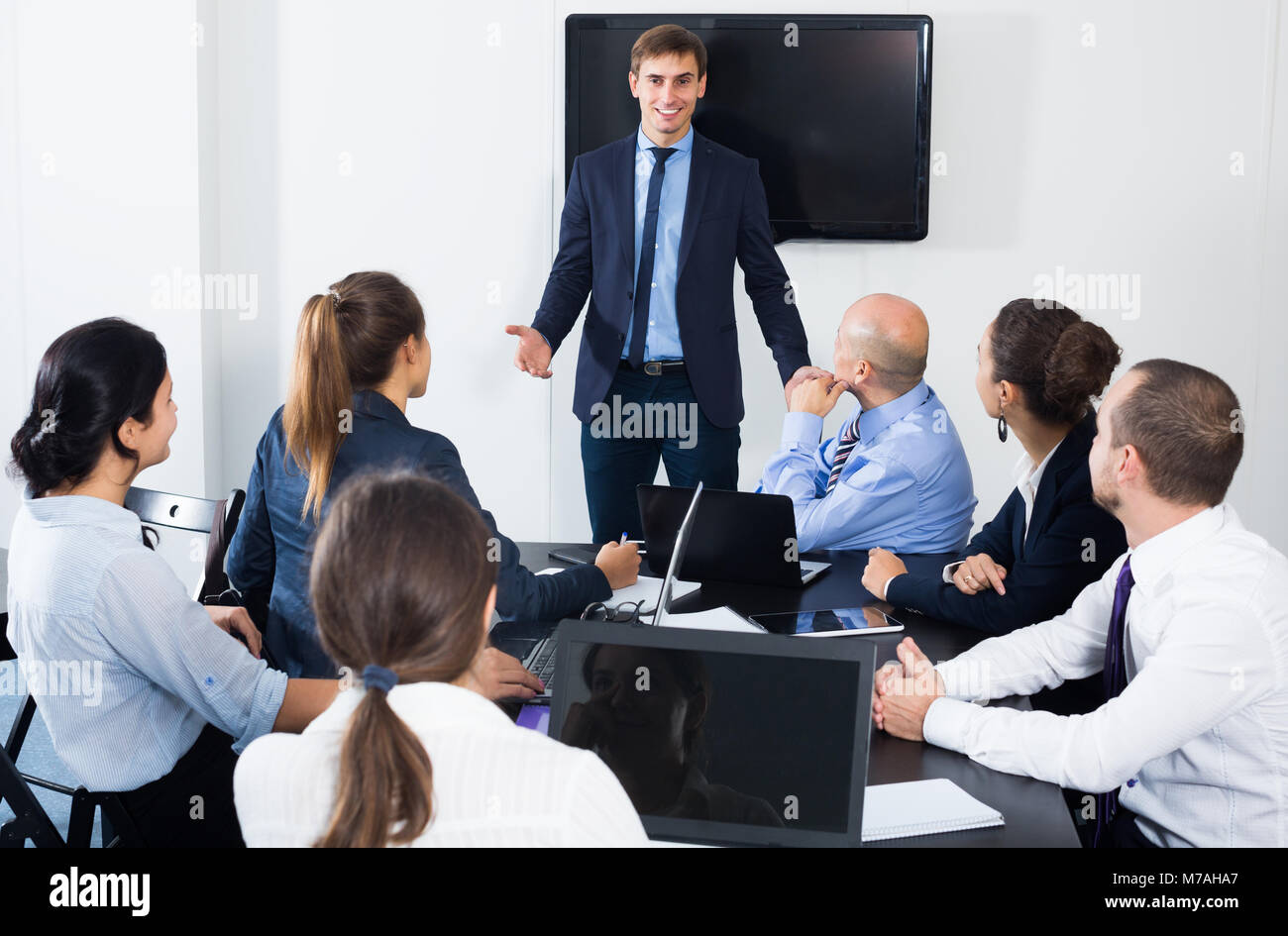 Male manager making presentation during business meeting in office ...