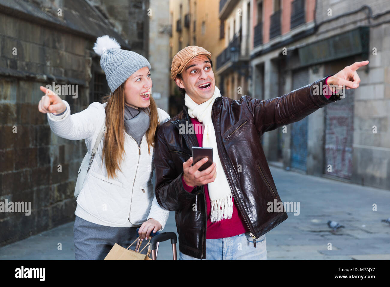 Positive male and female in the historic center pointing finger Stock ...