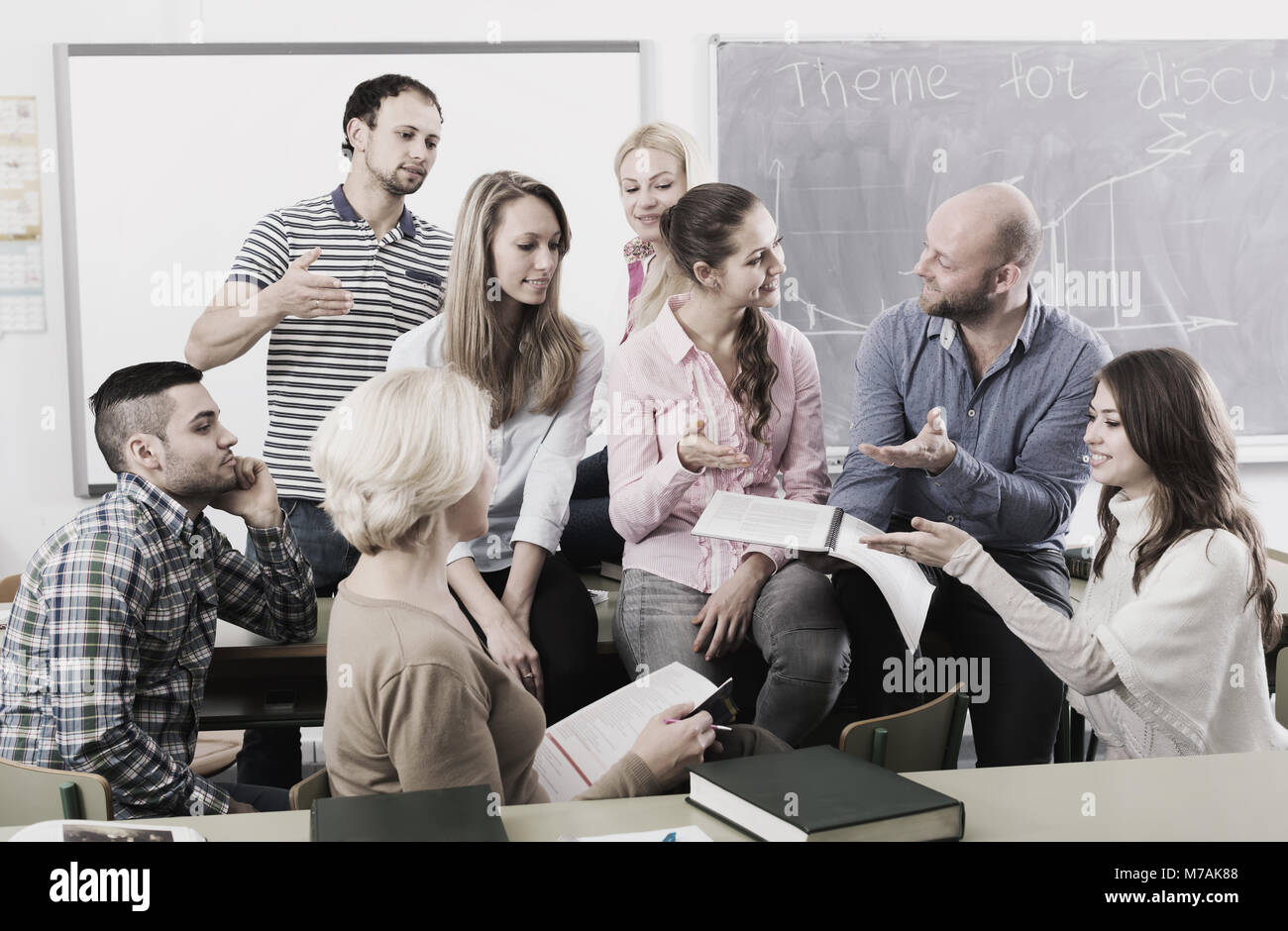 Teacher having informal discussion with his graduate students during a ...