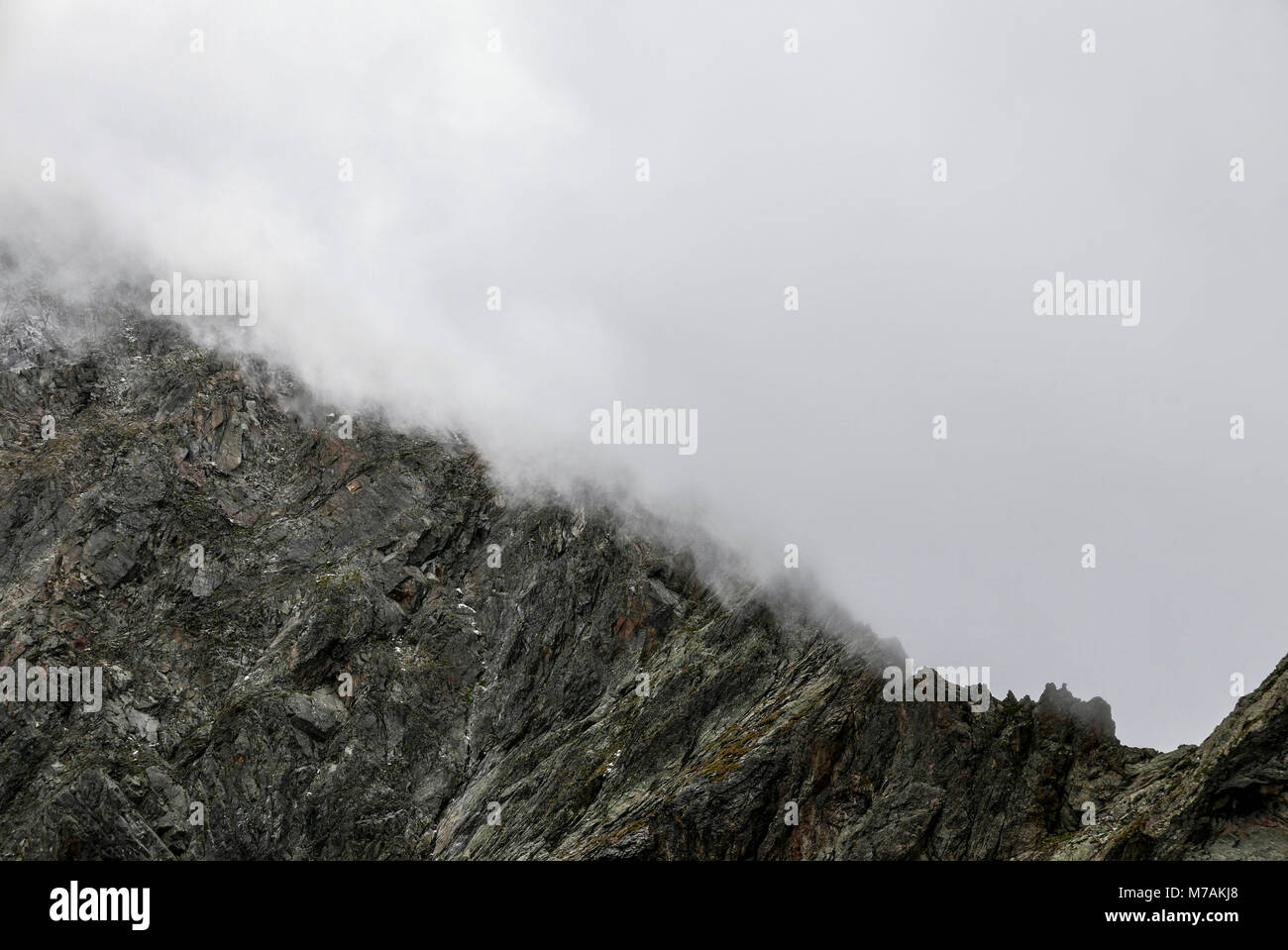 Clouds around the rocky ridge, primary rock, Tyrol Stock Photo - Alamy