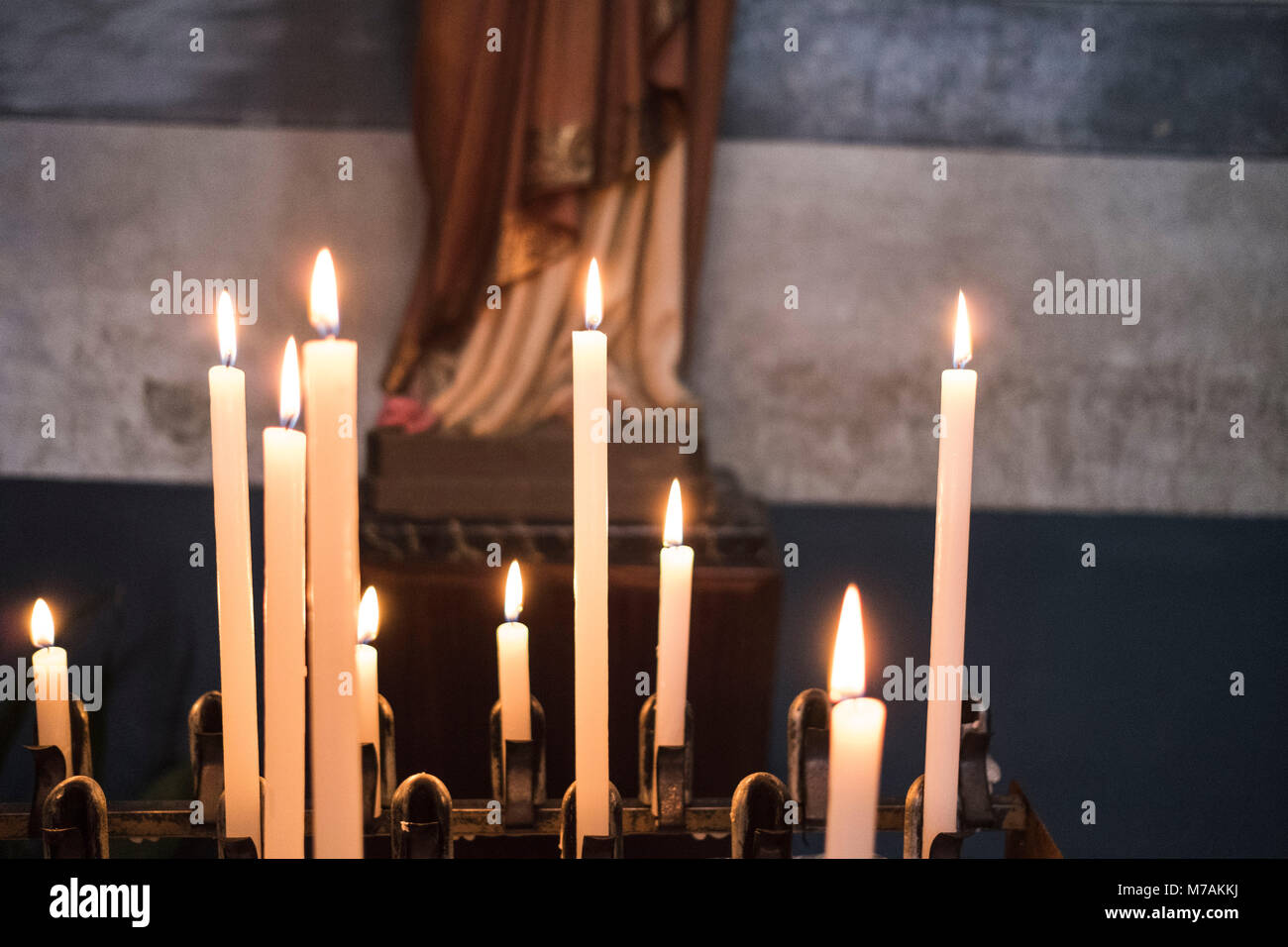 burning candles in front of Jesus statue, Italy, Liguria, Cinque Terre ...