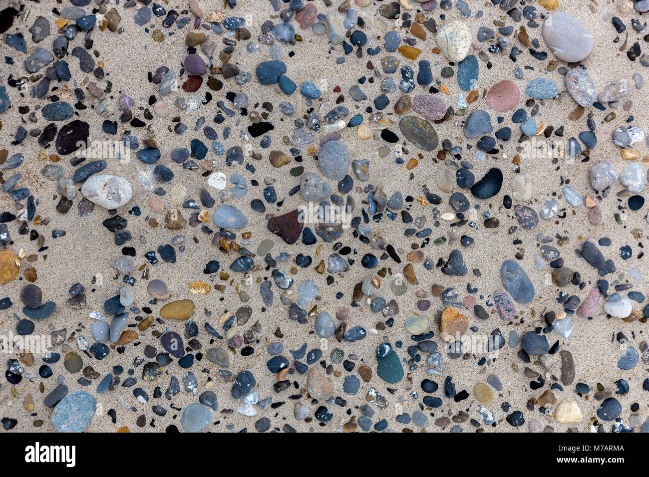 Stones in the sand on danish beach Stock Photo - Alamy