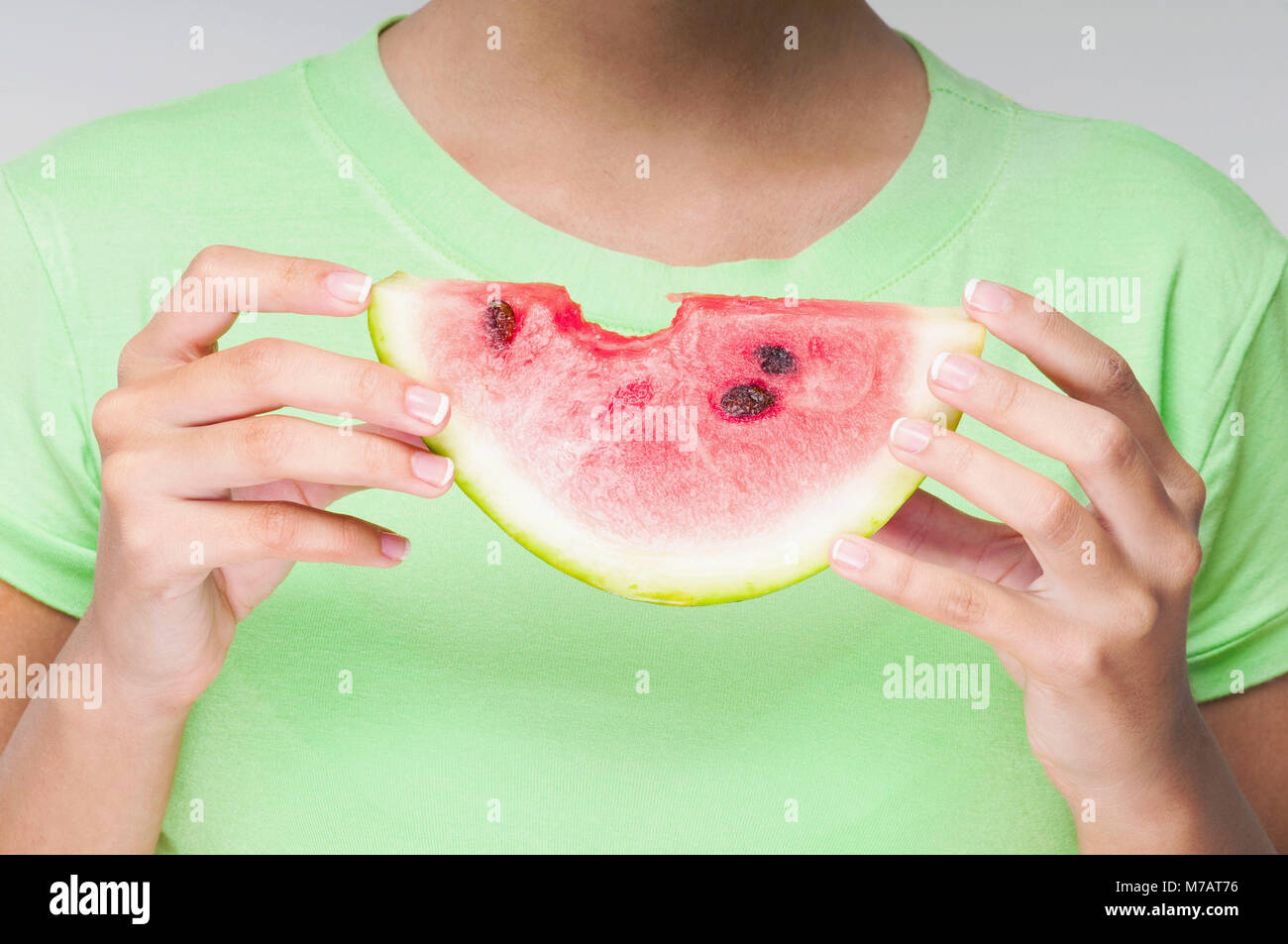 Mid section view of a woman holding a watermelon slice Stock Photo - Alamy