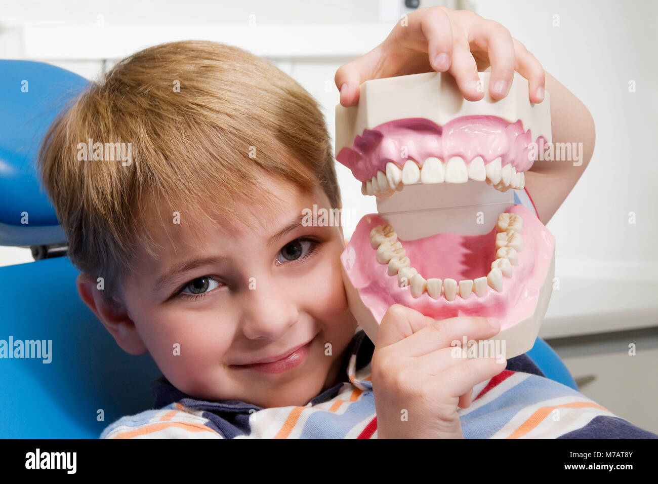 Portrait of a boy holding a set of dentures Stock Photo - Alamy