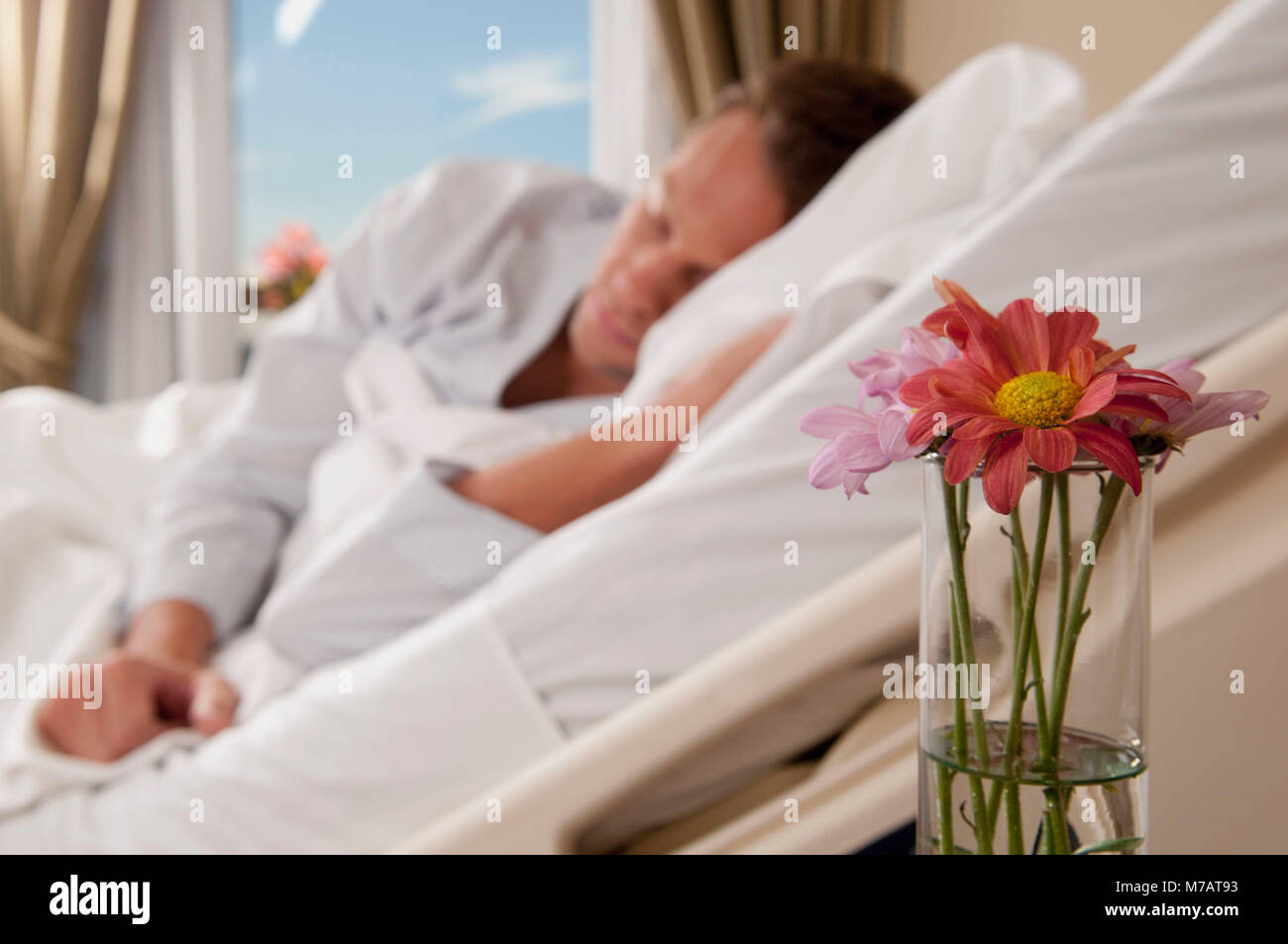 Man lying in a hospital bed Stock Photo - Alamy
