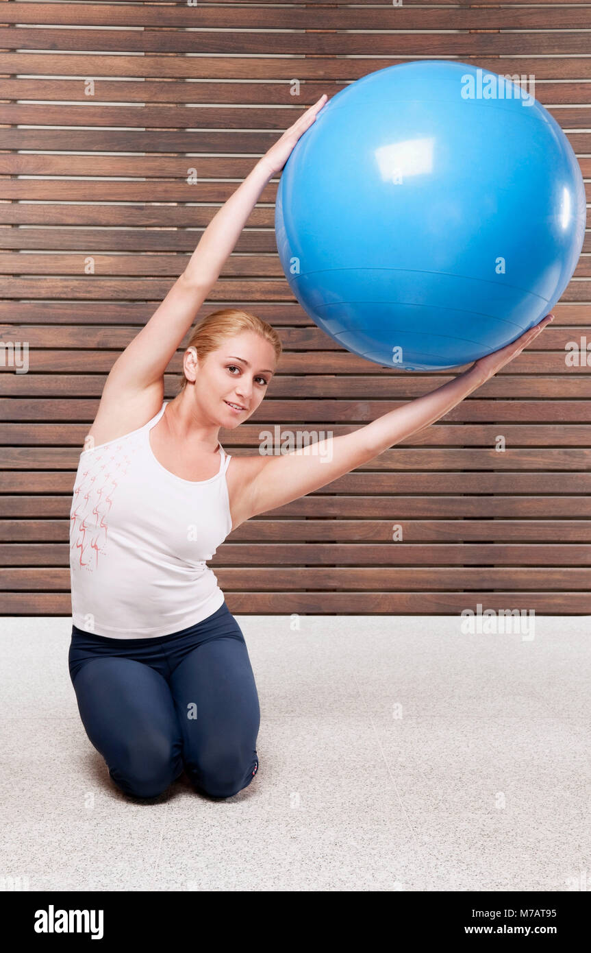 Woman exercising with a fitness ball Stock Photo - Alamy