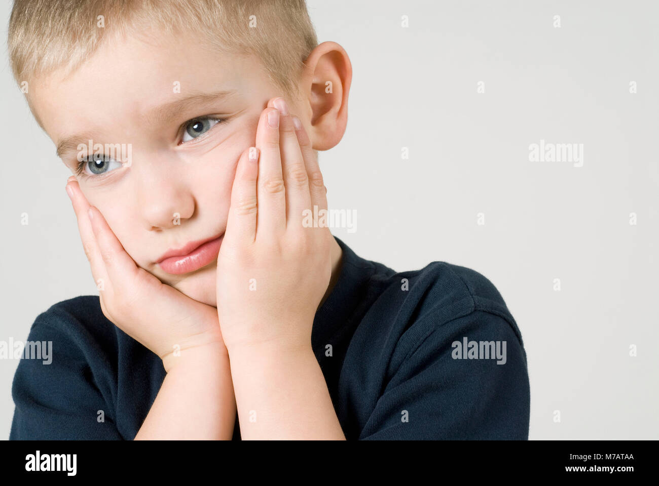 Close-up of a boy looking sad Stock Photo - Alamy