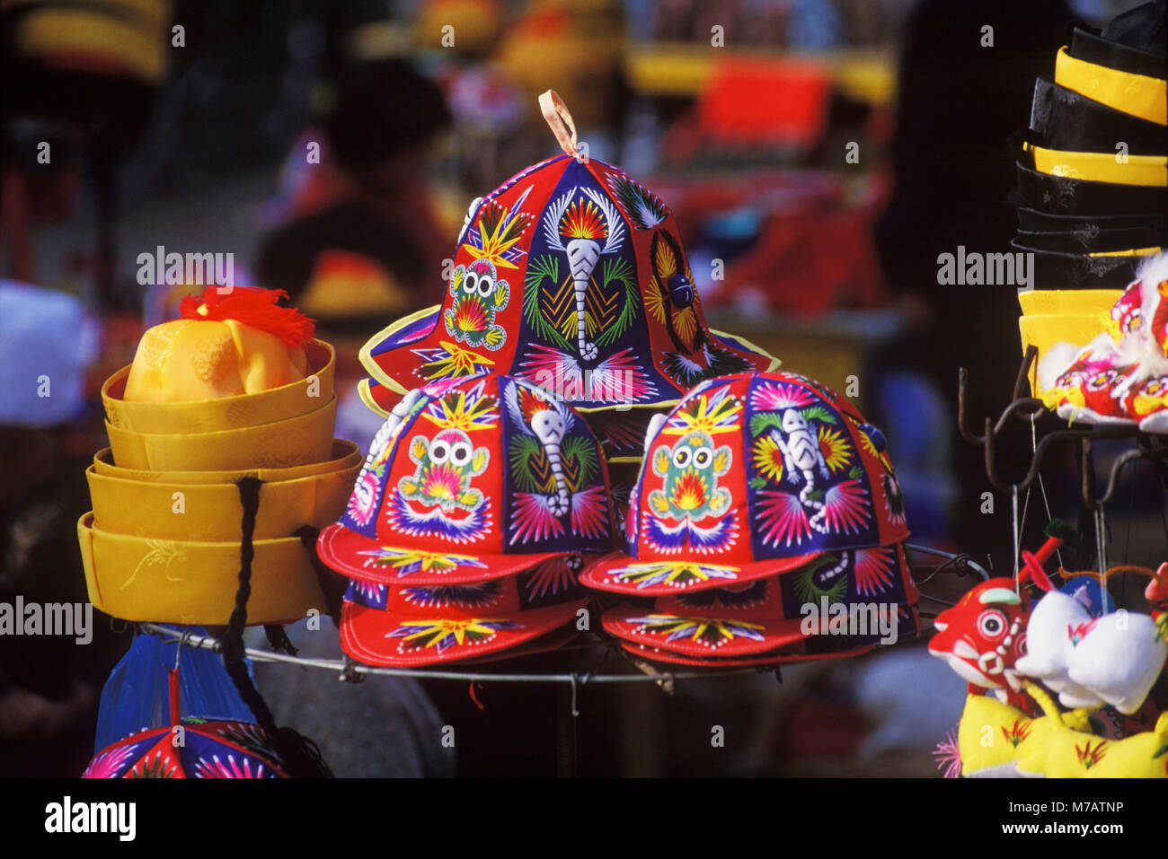 Close-up of caps and toys in a market Stock Photo - Alamy