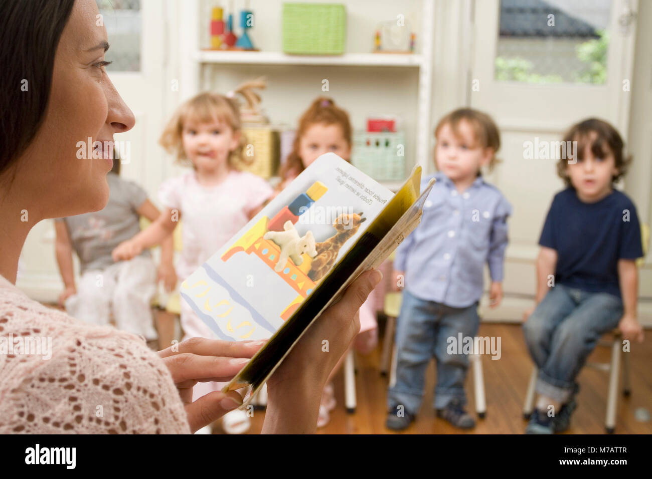 Female teacher teaching her students in a classroom Stock Photo - Alamy