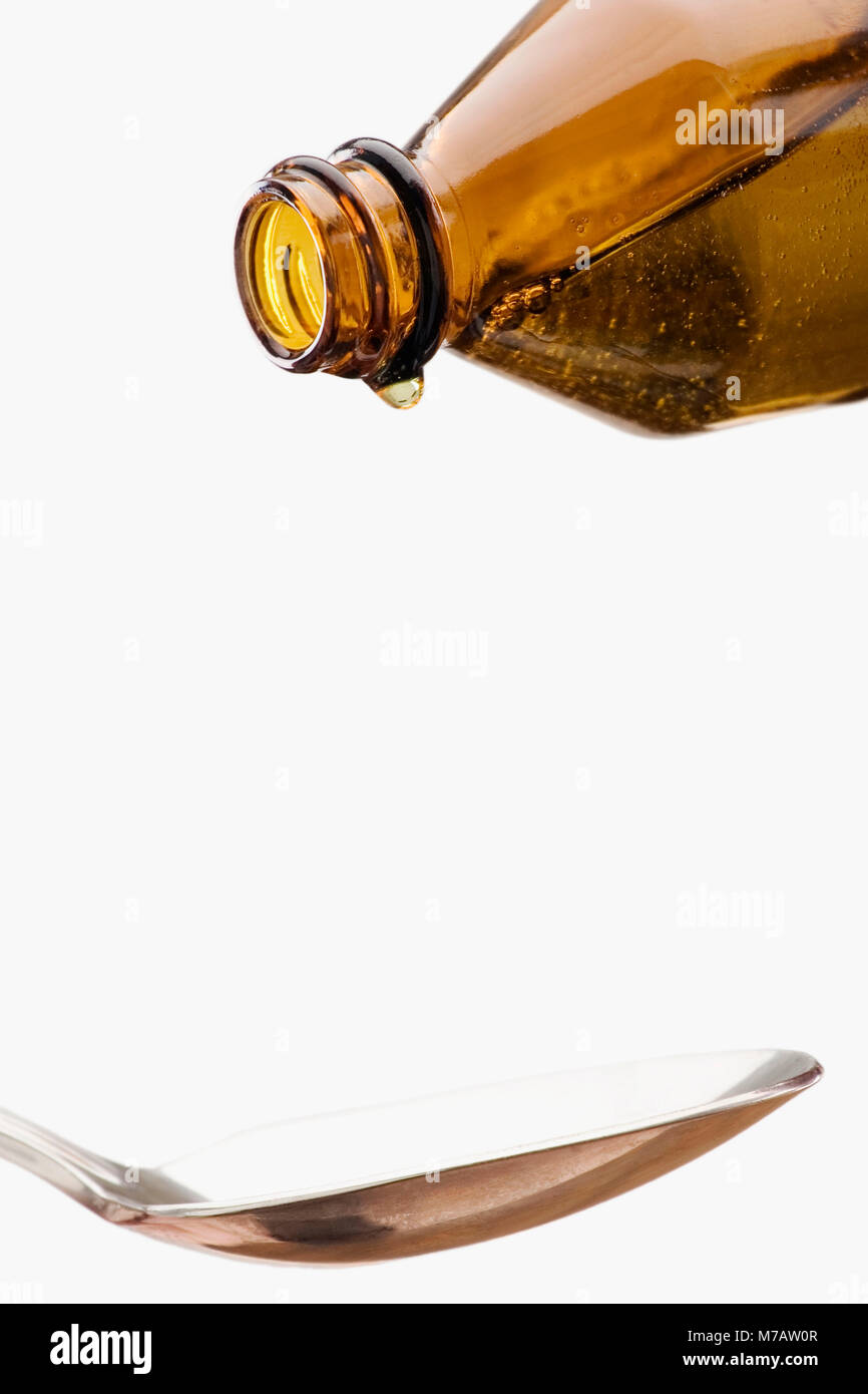 Liquid medicine pouring into spoon Stock Photo - Alamy
