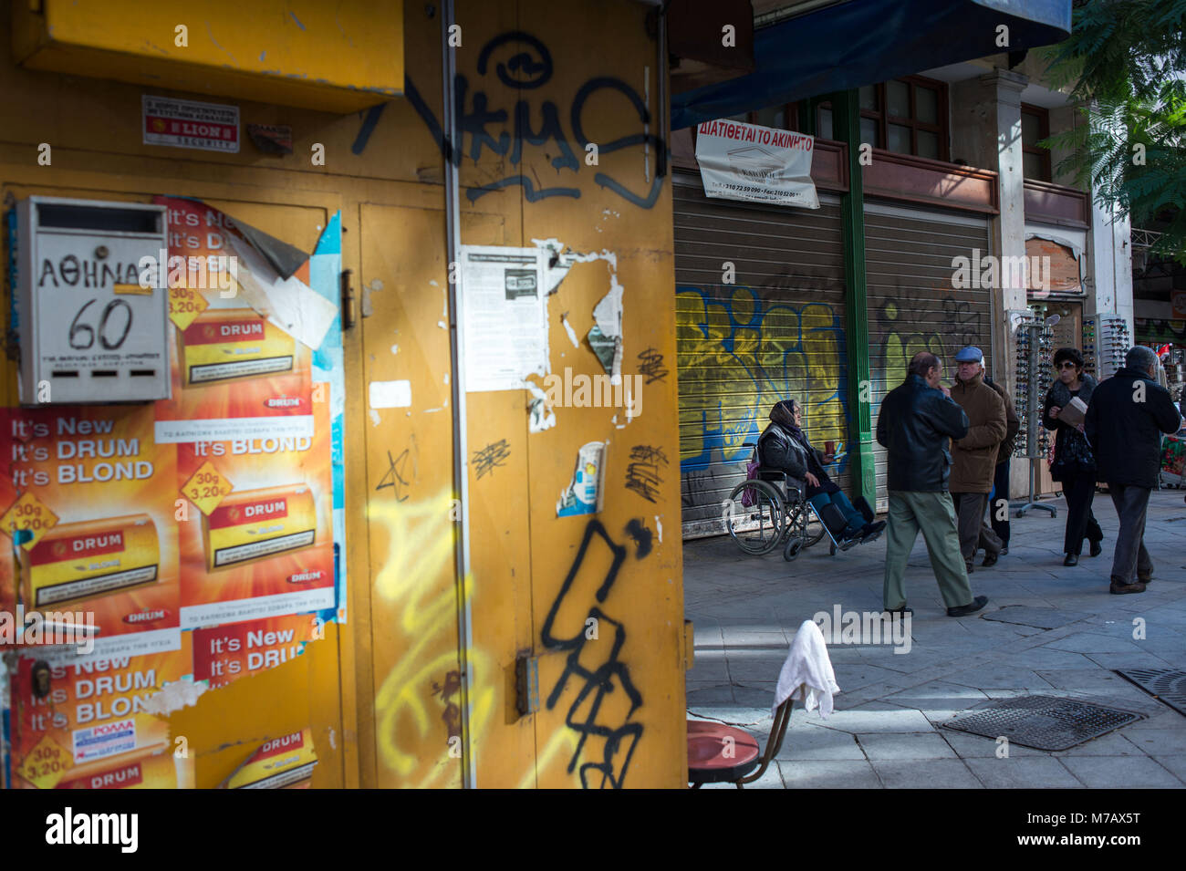 Athens. Old woman on a wheel chair begging. Greece Stock Photo - Alamy