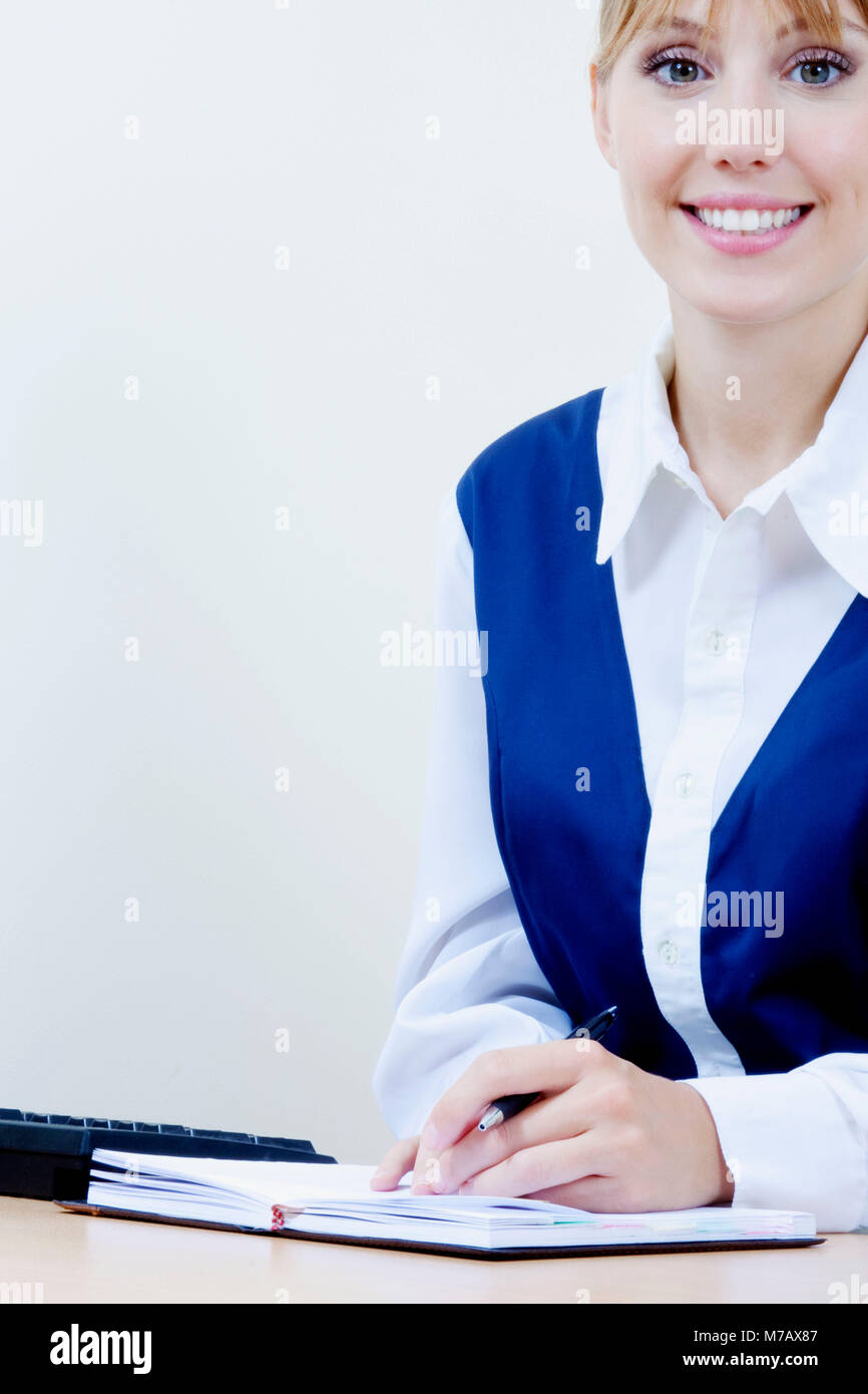 Young female receptionist in formal hi-res stock photography and images ...