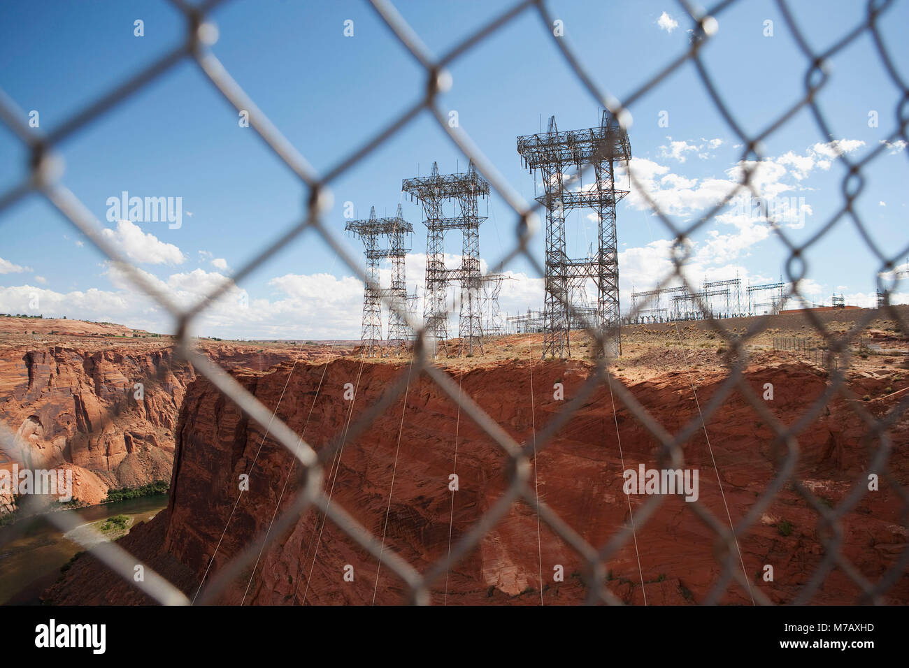 Electricity pylons viewed from a chainlink fence, Glen Canyon Dam, Lake ...