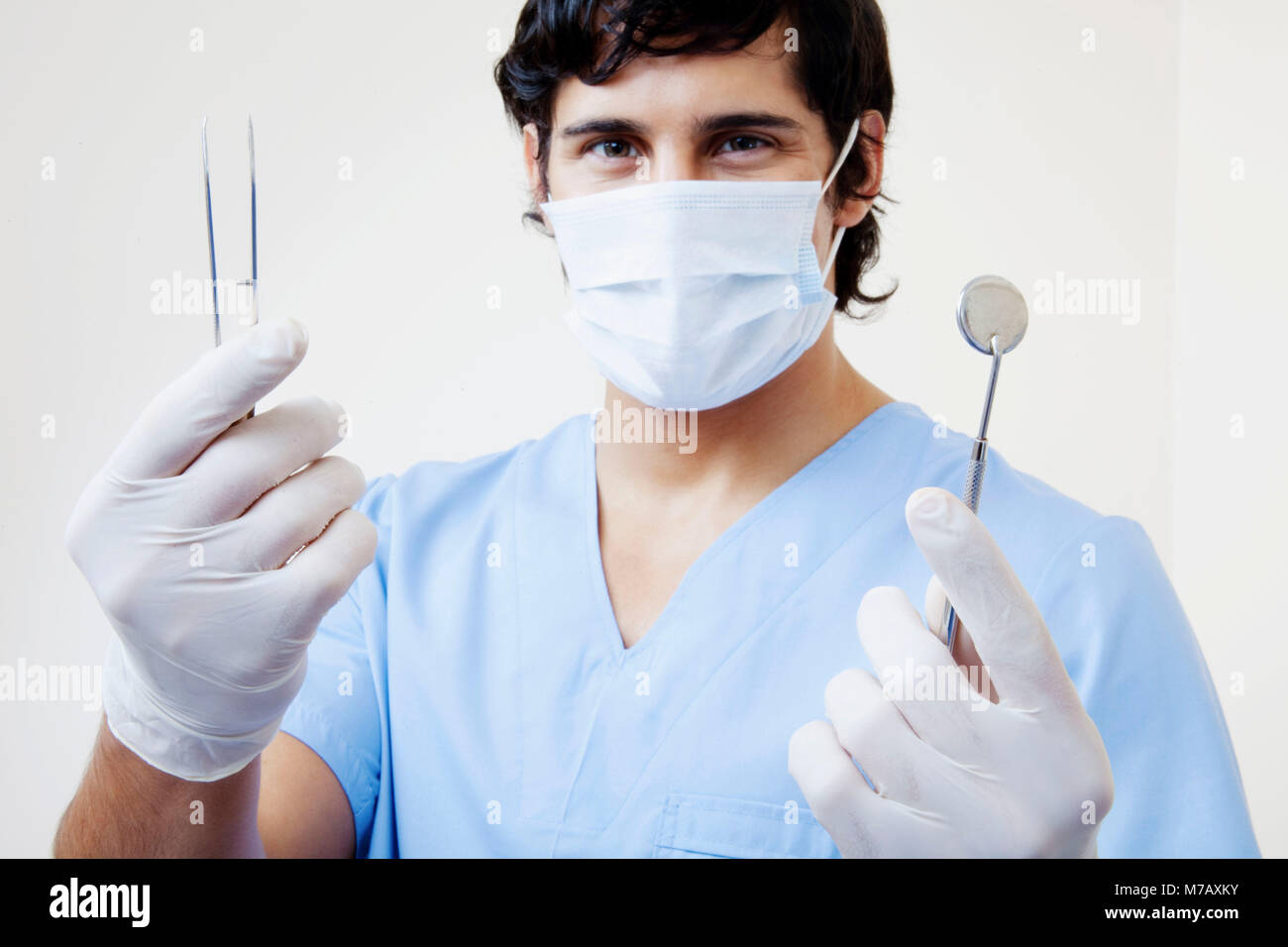 Dentist holding dental instruments in a clinic Stock Photo - Alamy