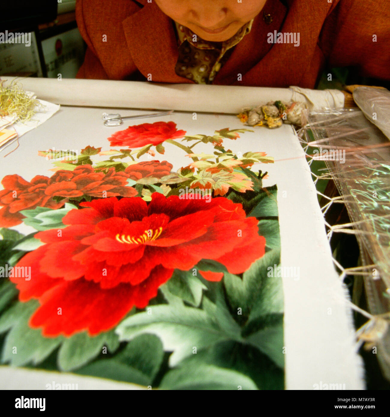 Mid section view of a woman embroidering a sheet, Zhouzhuang, Kunshan ...