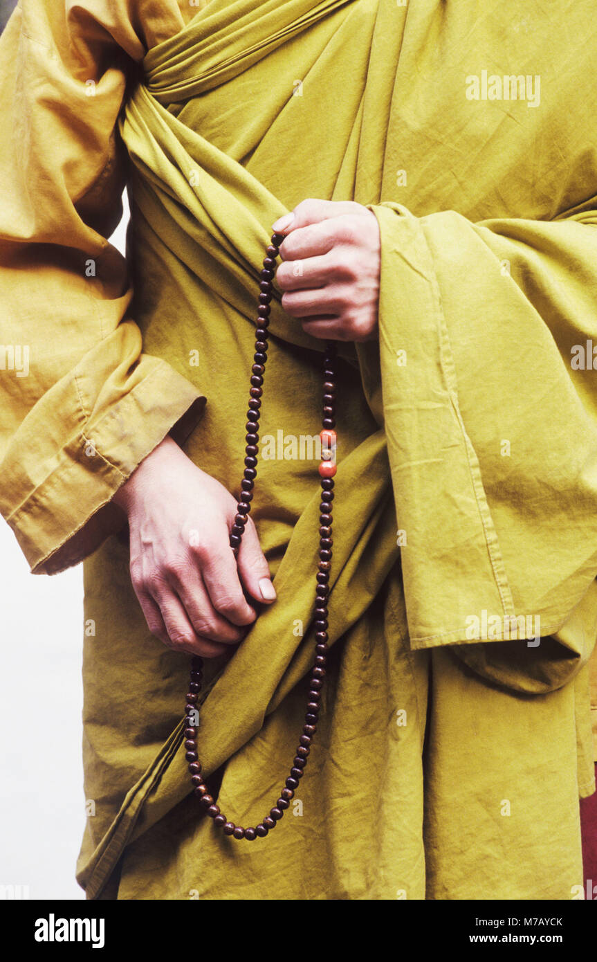 Mid section view of a monk holding prayer breads Stock Photo - Alamy